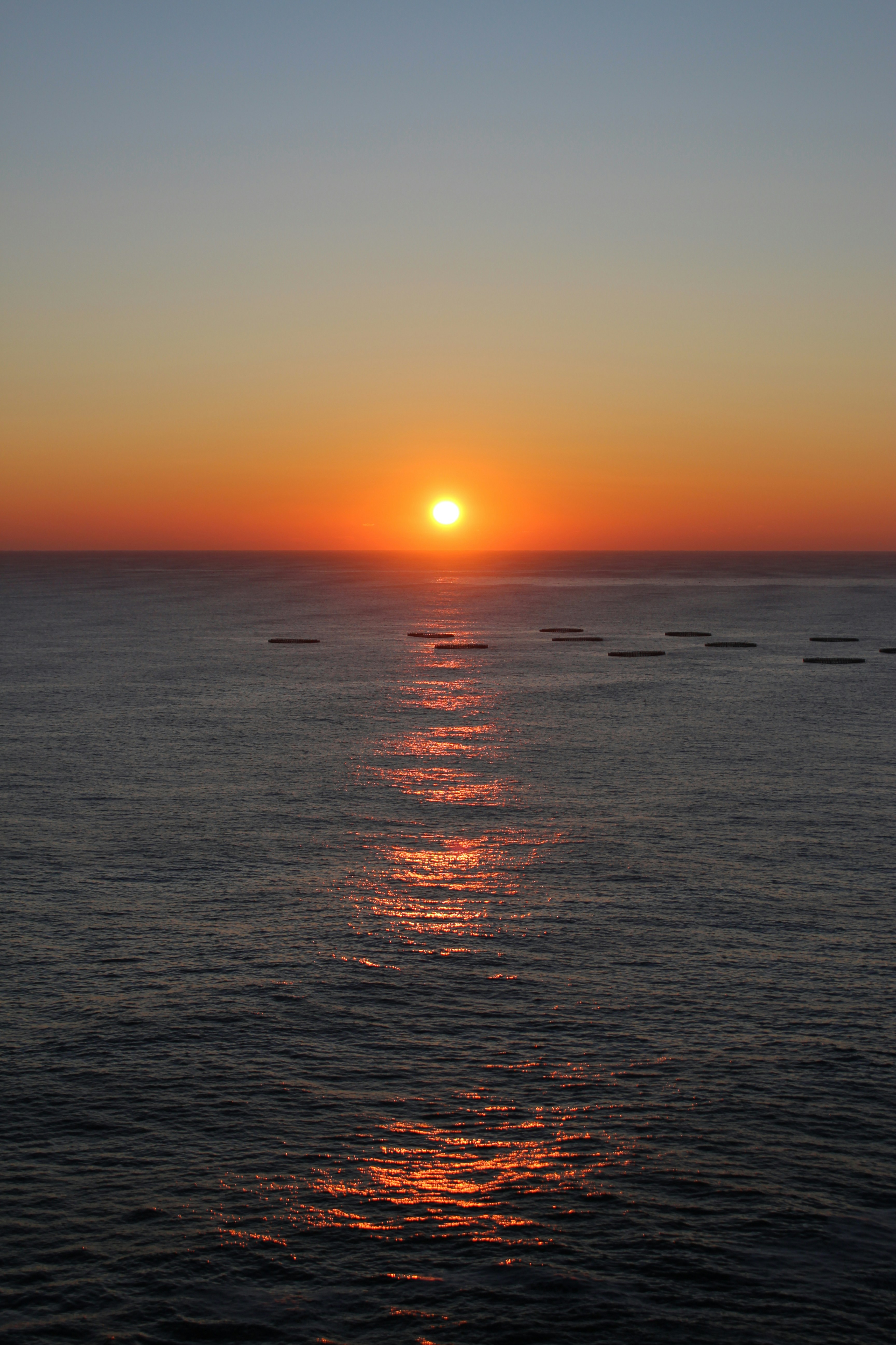 Sunlit Horizon: A Calm Sea at Dusk