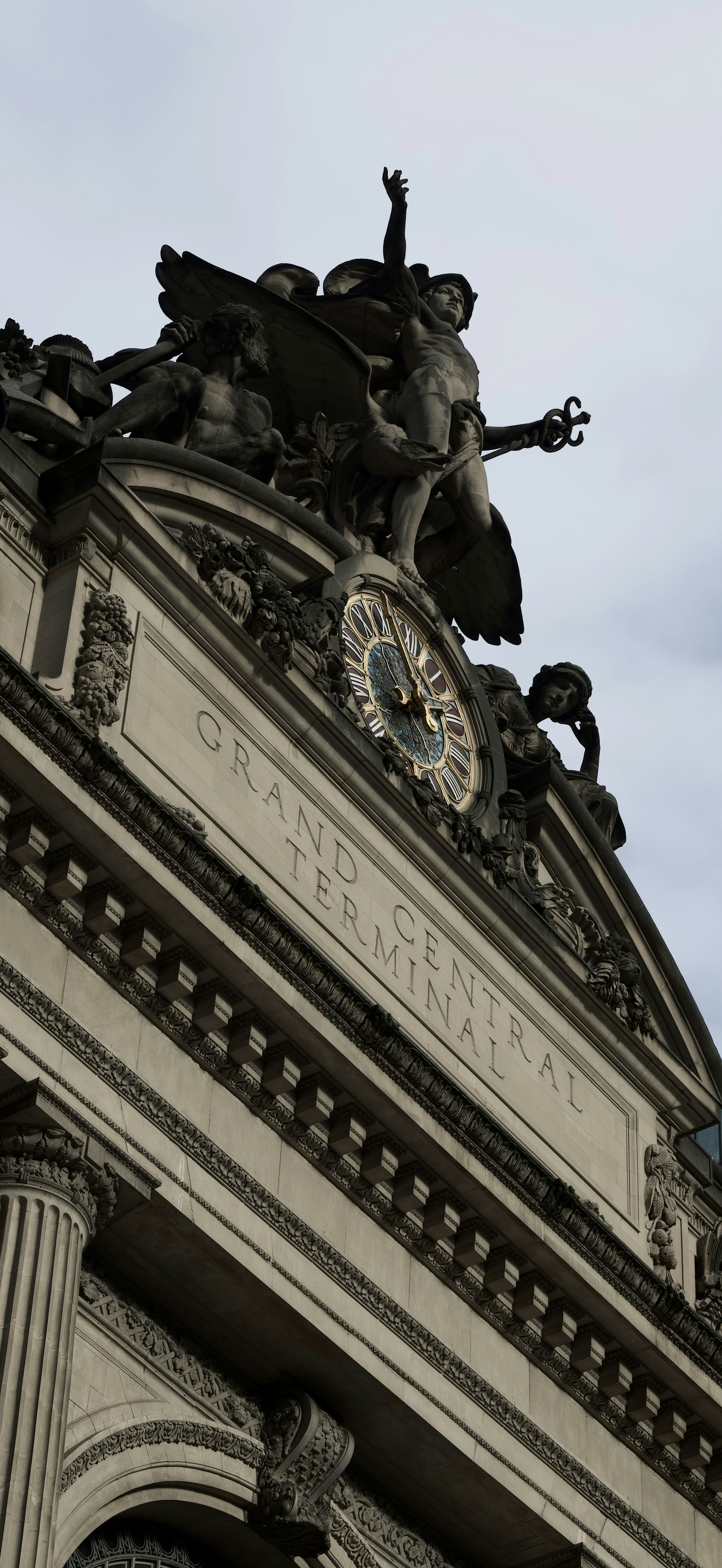 Timeworn Grandeur: Sculpted Guardians Over the Clock