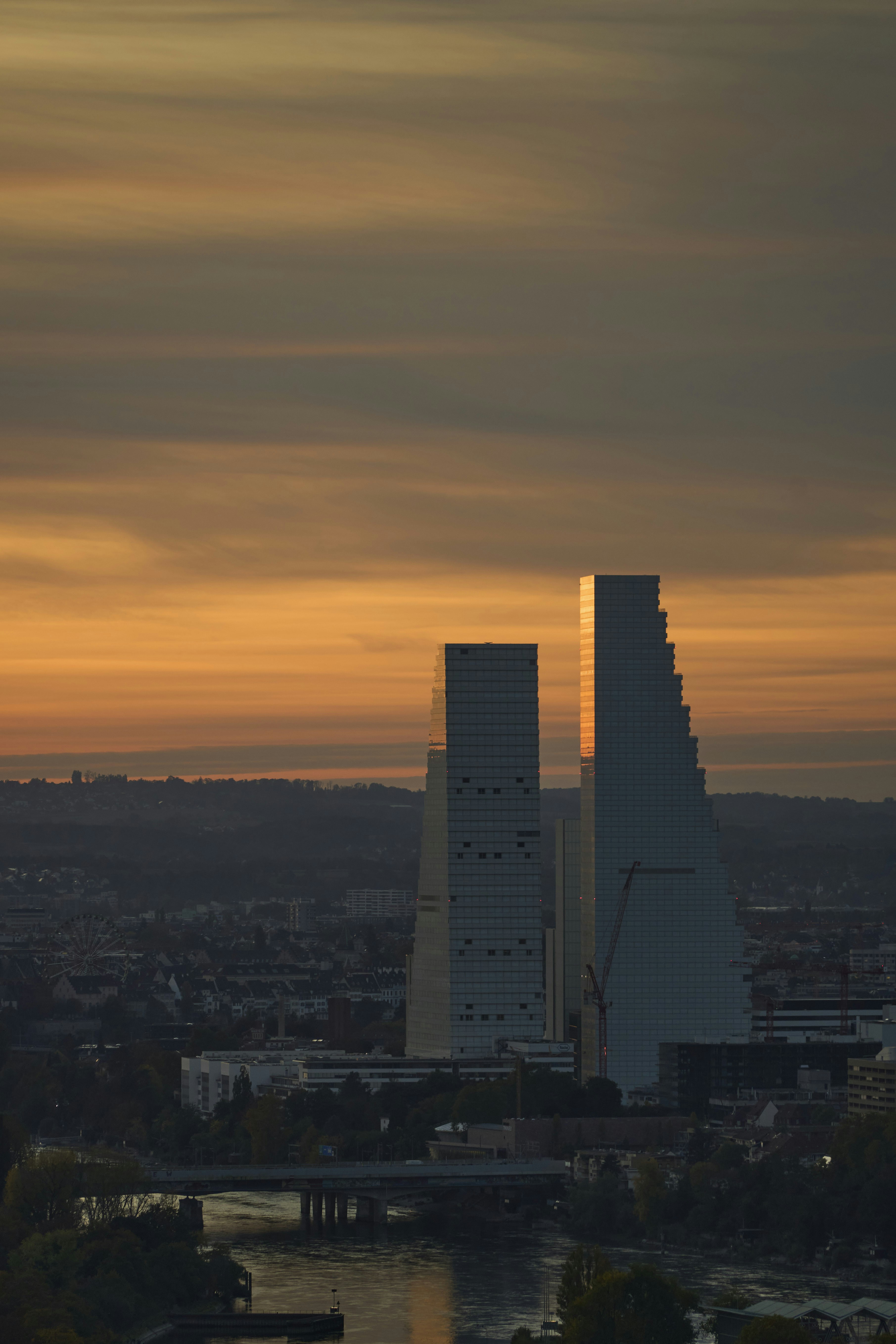 Sunset Skyline: Twin Towers Rising Over Quiet Waters