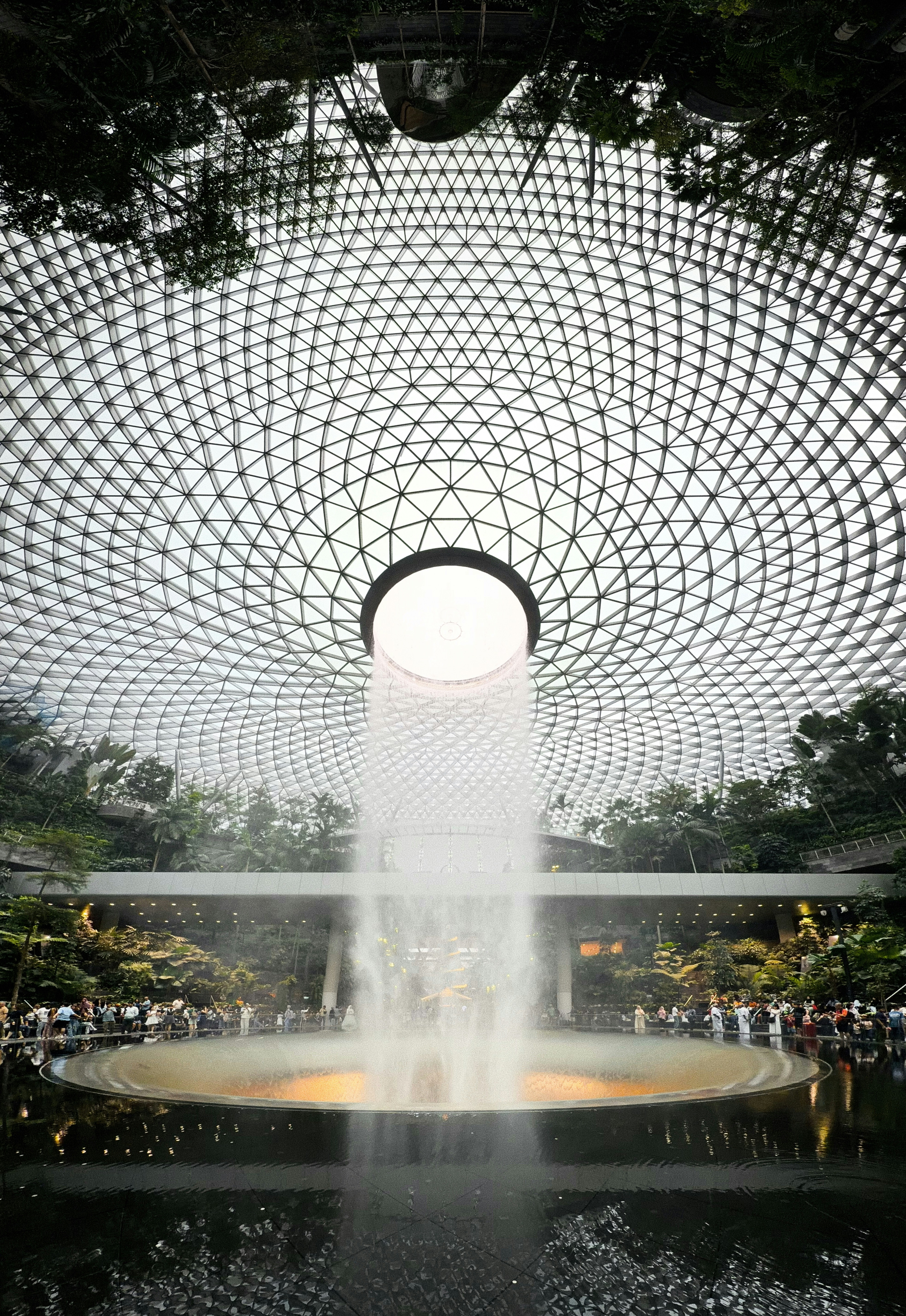 A series captured inside Jewel Changi Airport, featuring the Rain Vortex surrounded by a vast glass dome and indoor forest. Water cascades through the geometric ceiling while greenery and reflections soften the monumental scale. The contrast between structure, nature, and motion creates a calm yet immersive atmosphere within one of the world’s busiest airports.