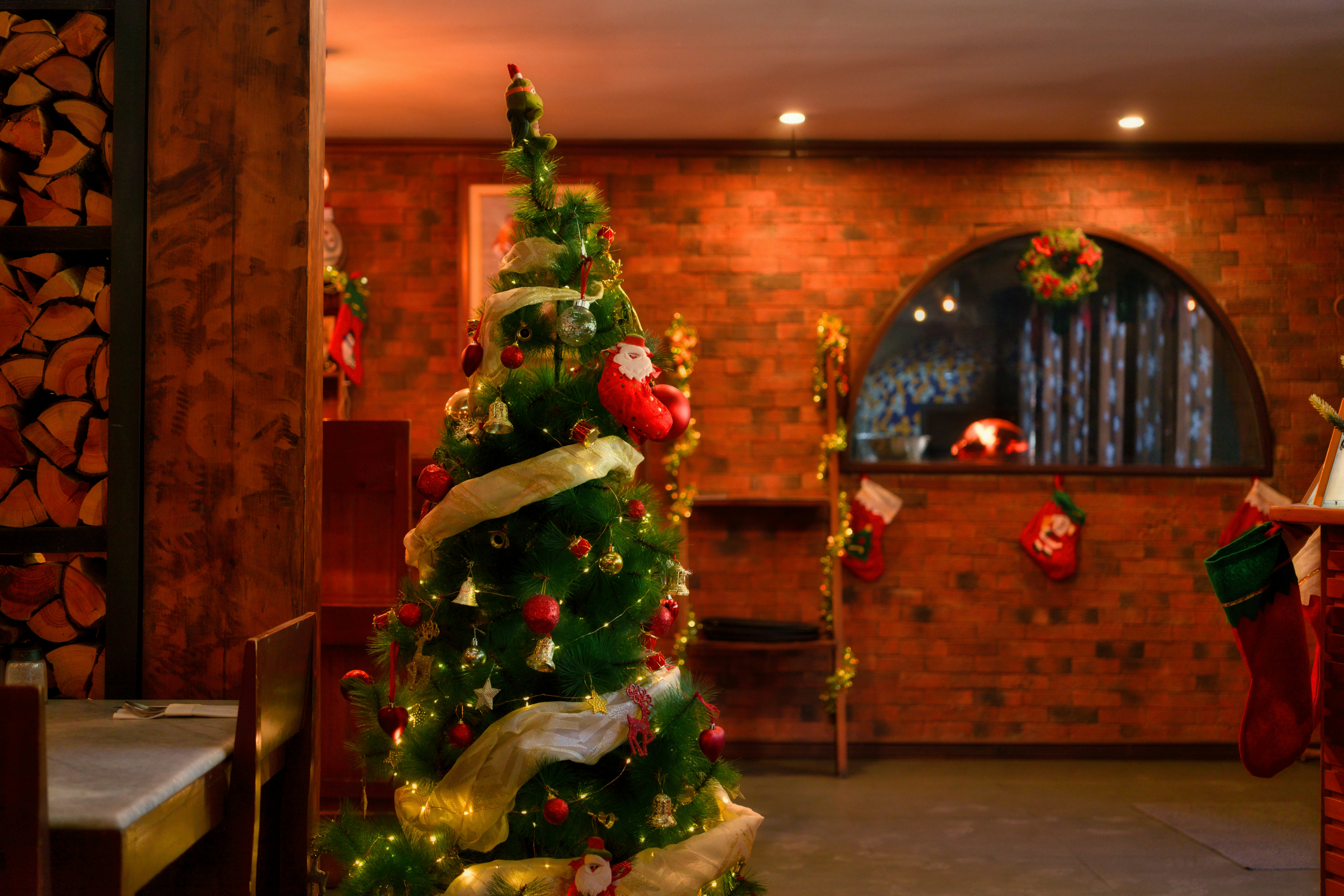 Cozy Christmas Corner: A Decorated Tree Beneath Warm Arcade Lights