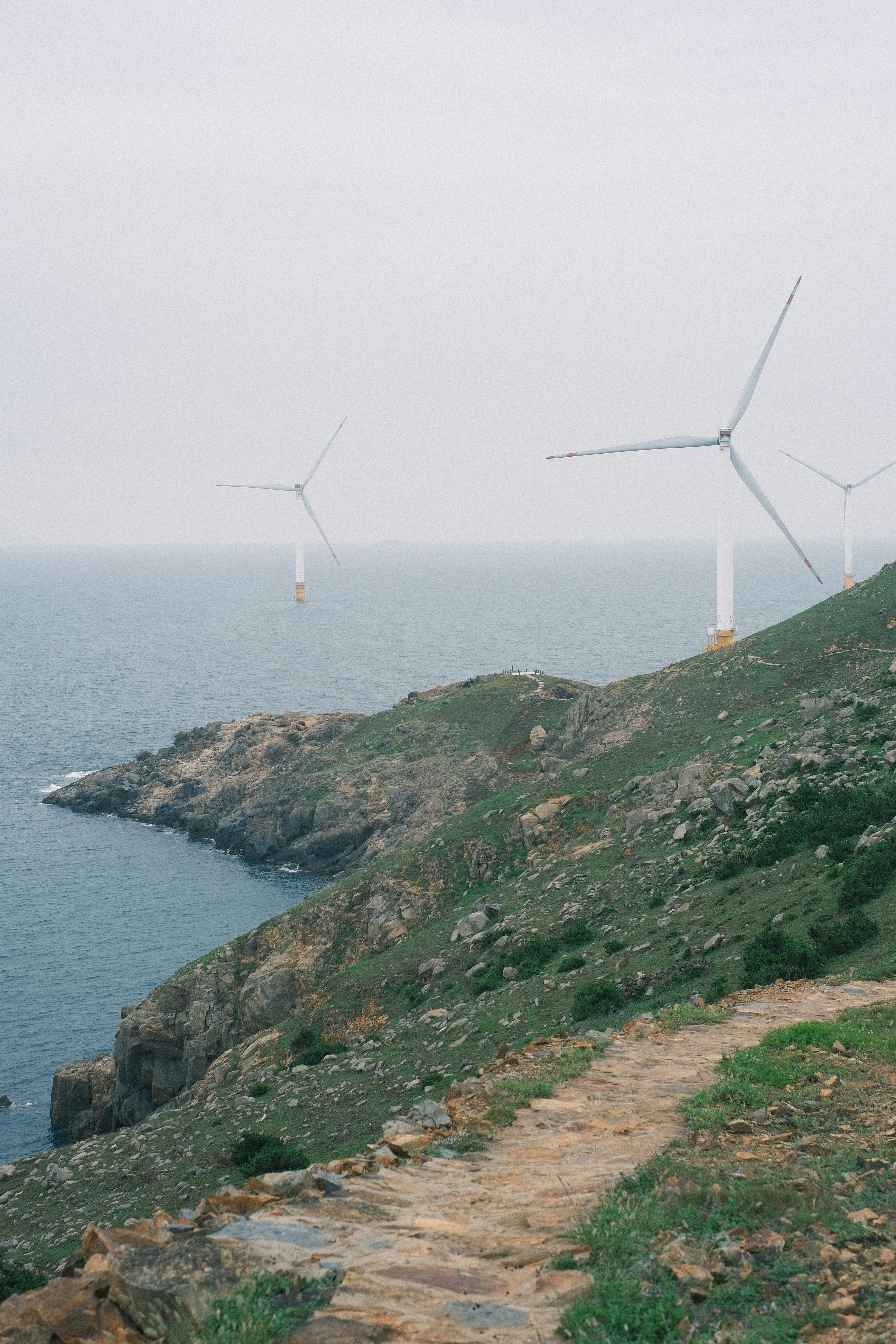 Coastal Windmills Beneath Overcast Skies