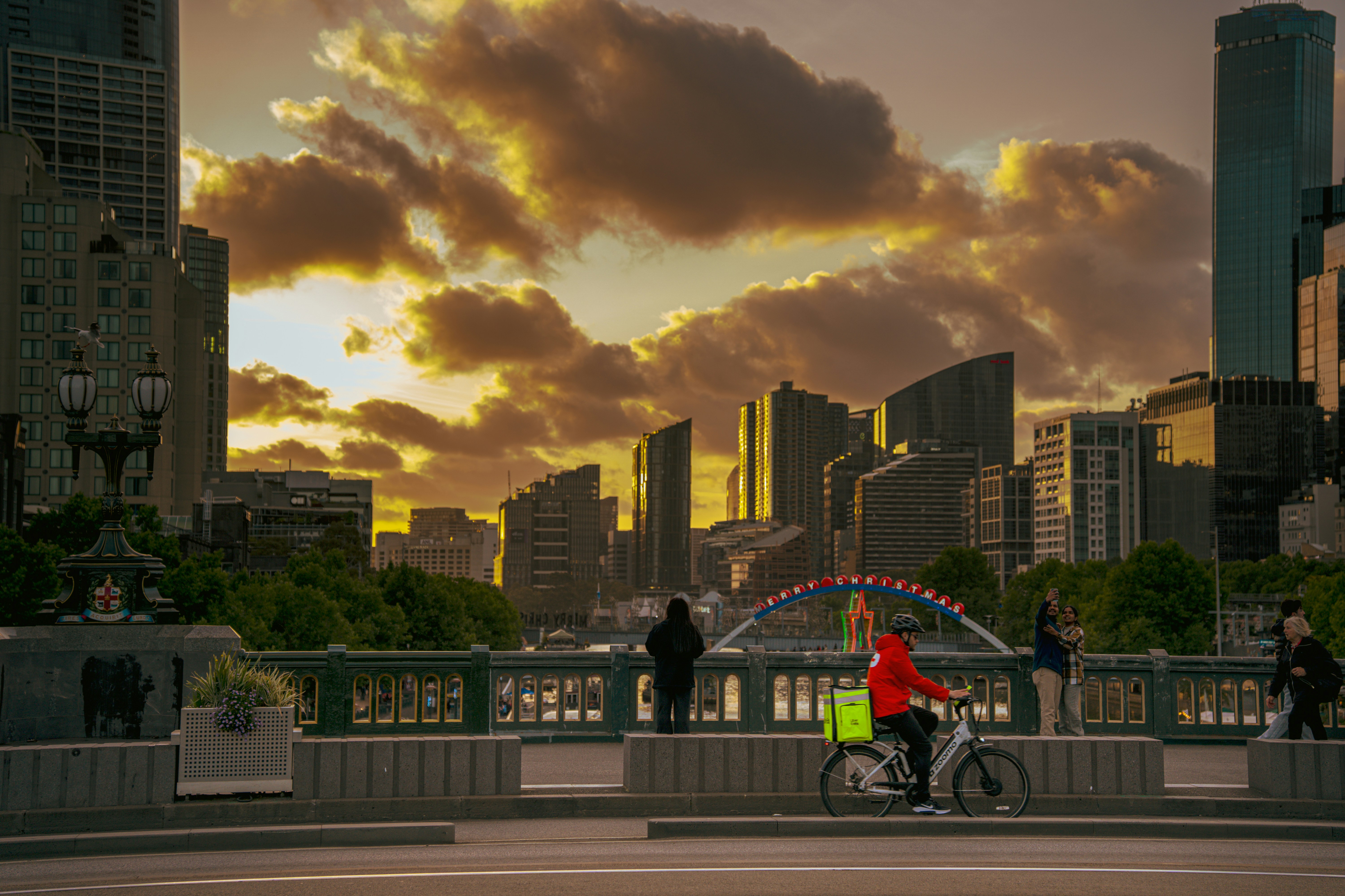 Golden Hour Crossing: Cyclist in a Neon City
