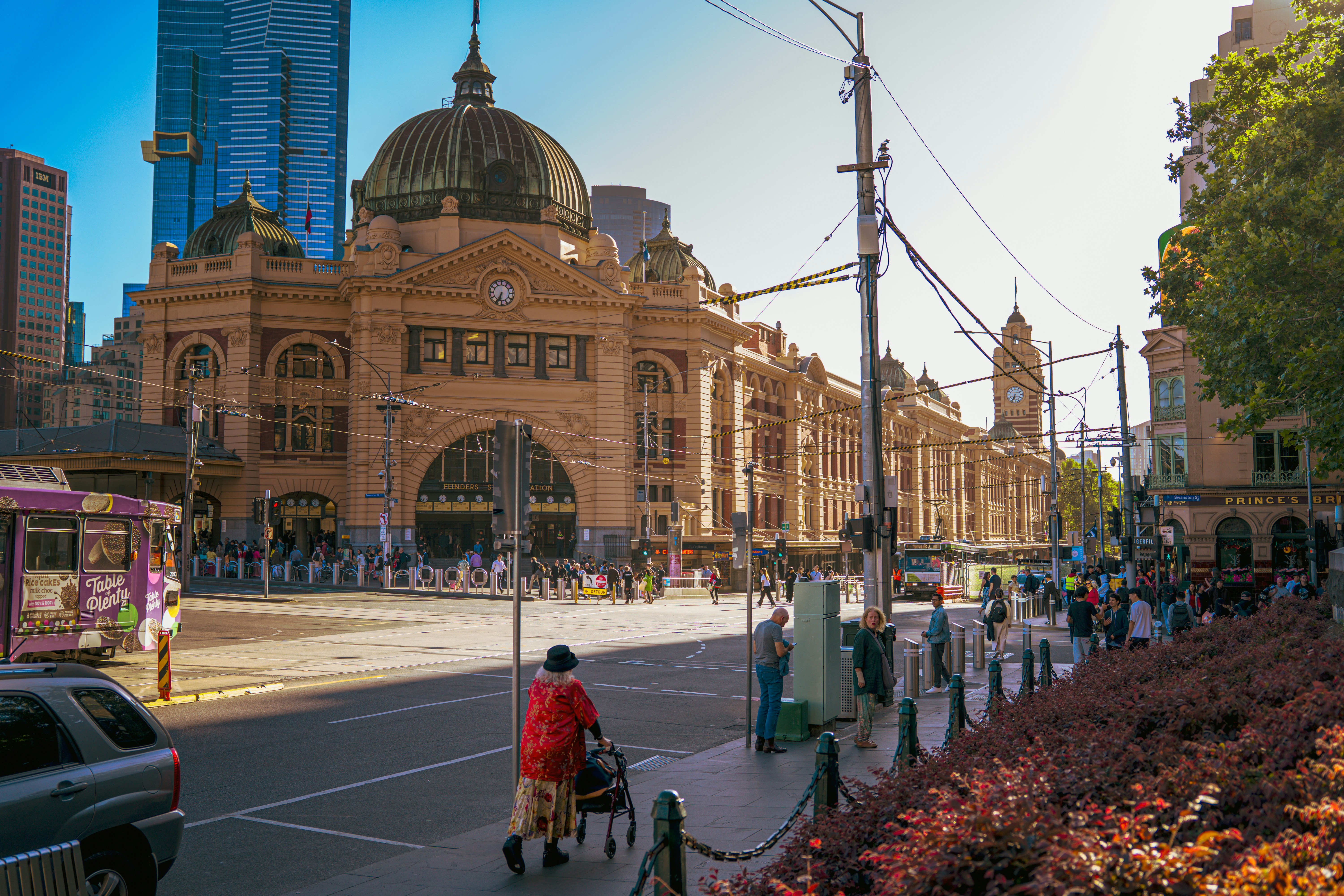 City Landmark at Ground Level: A Sunlit Arcade and Busy Street