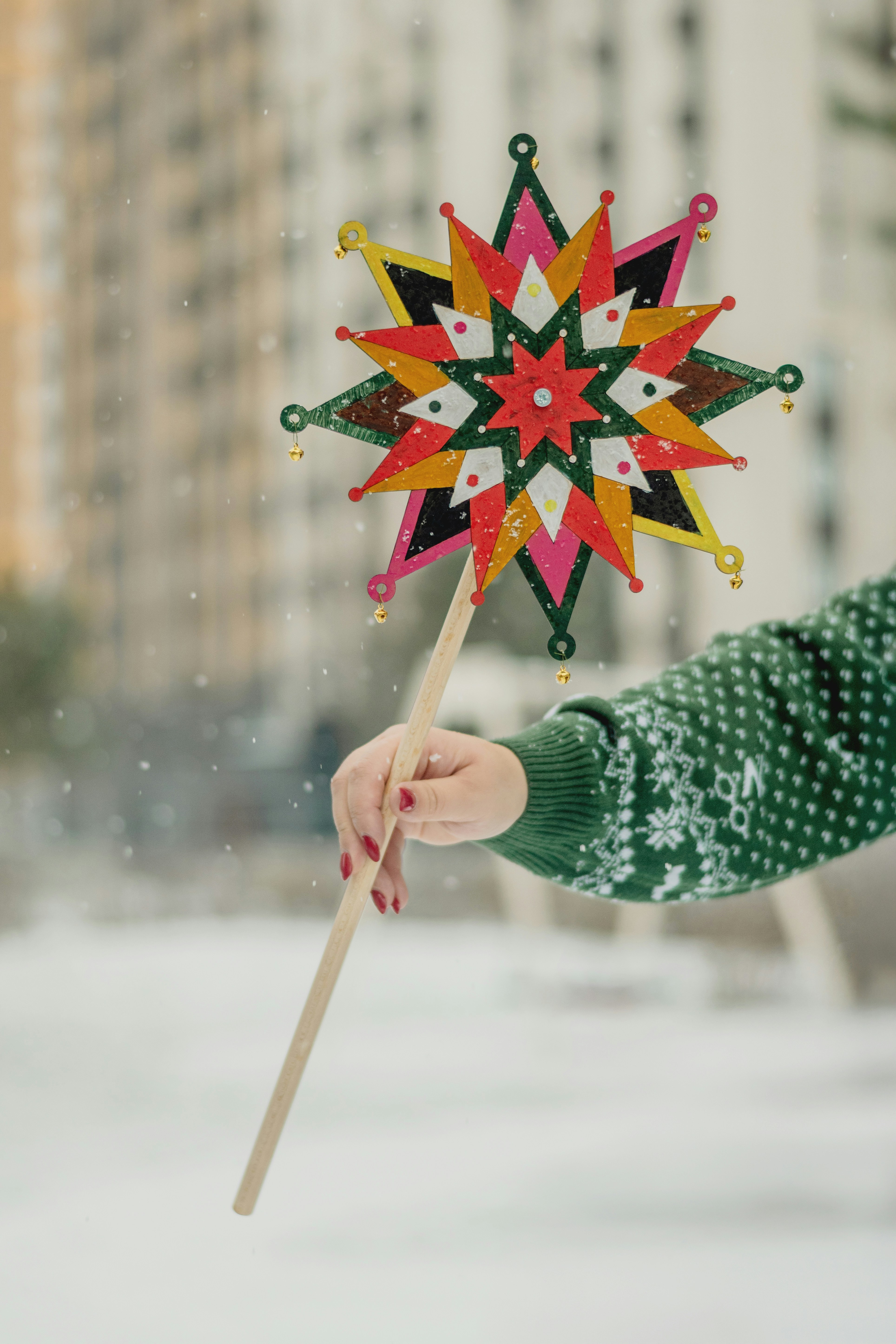 Colorful star and gloved hand: a festive snow scene in motion