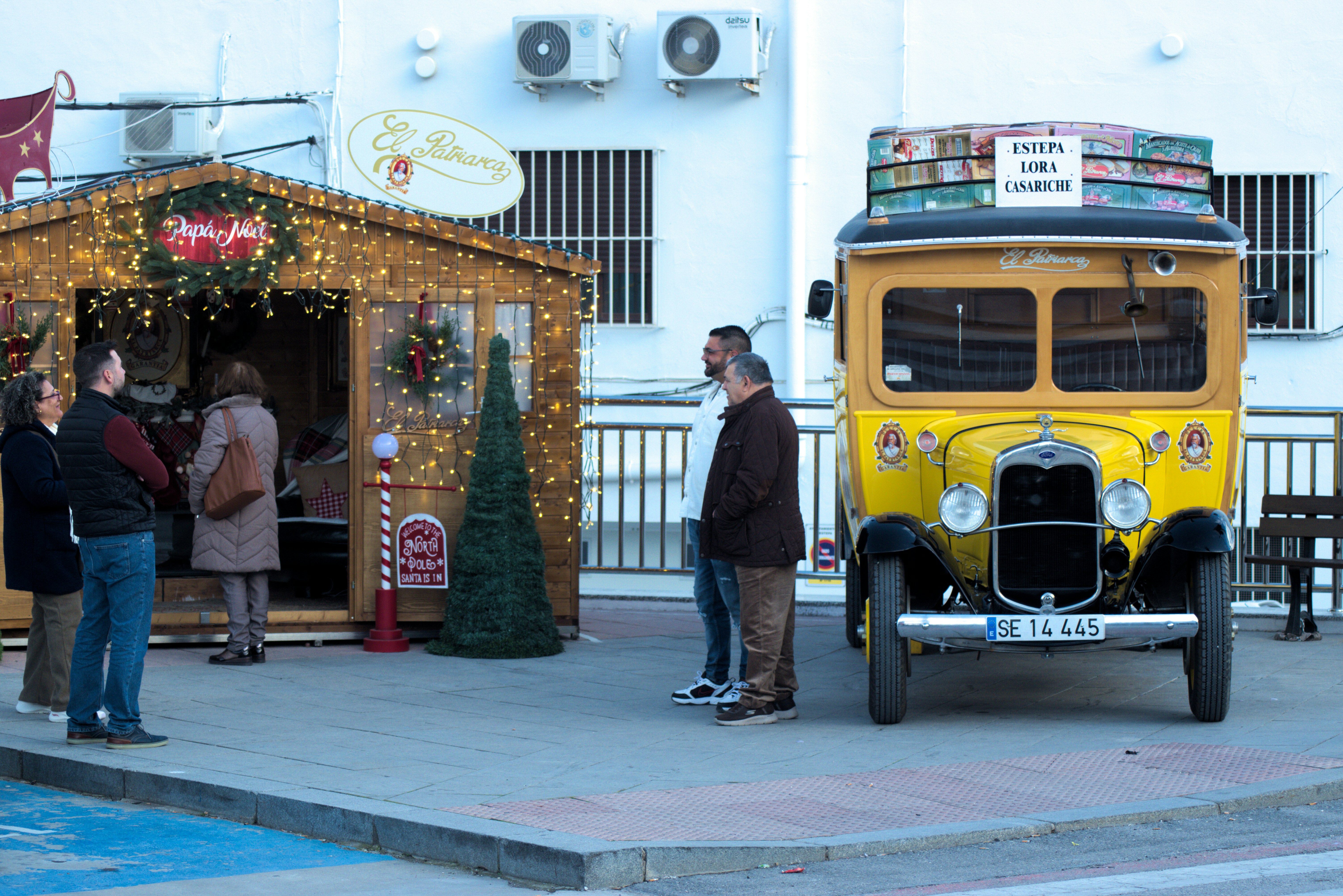 Yellow vintage bus at the edge of a festive street scene
