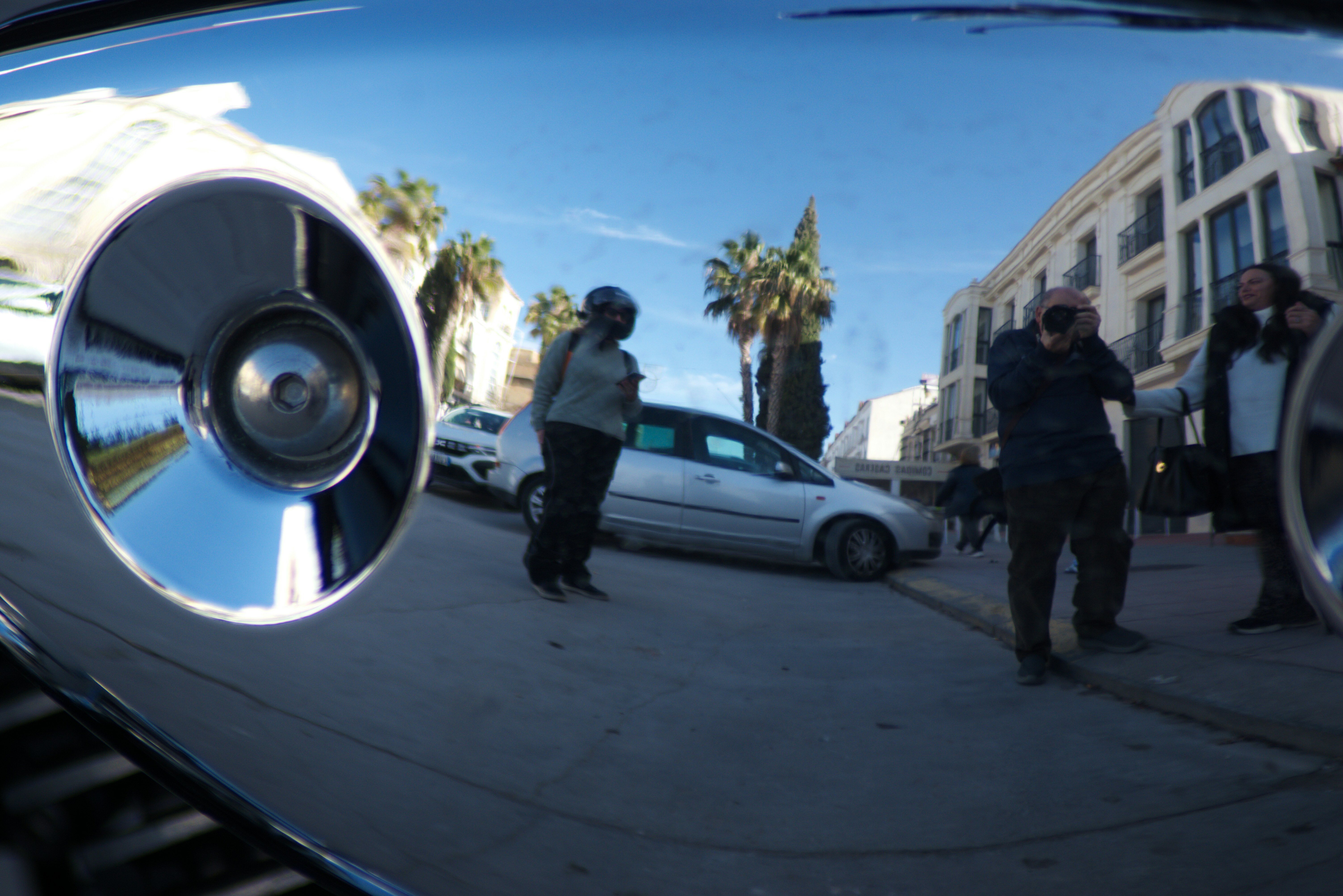 this is an ordonary street reflected on a shiny motorcycle