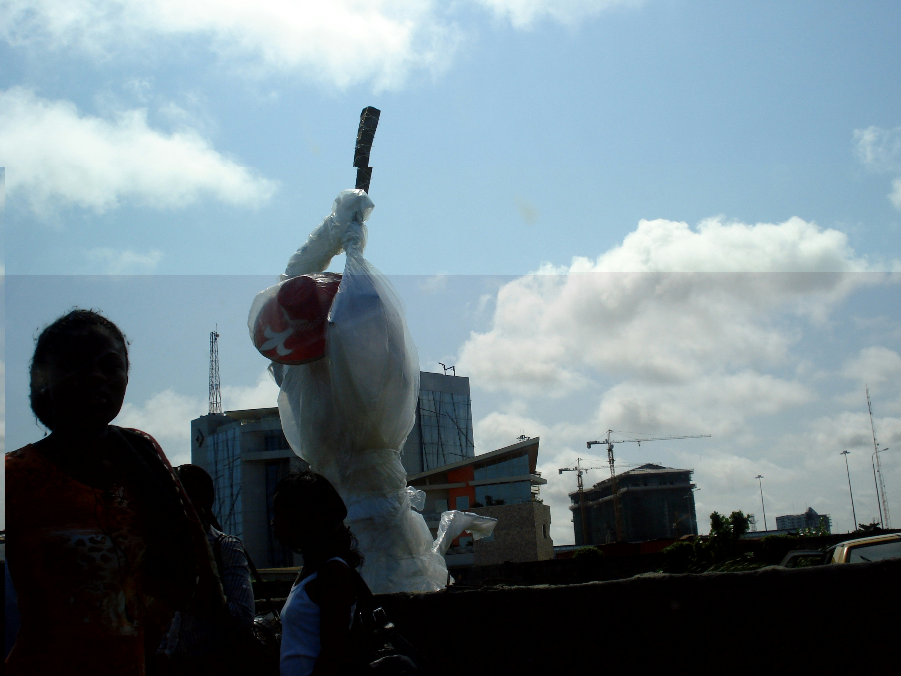 White object held up against cloudy sky