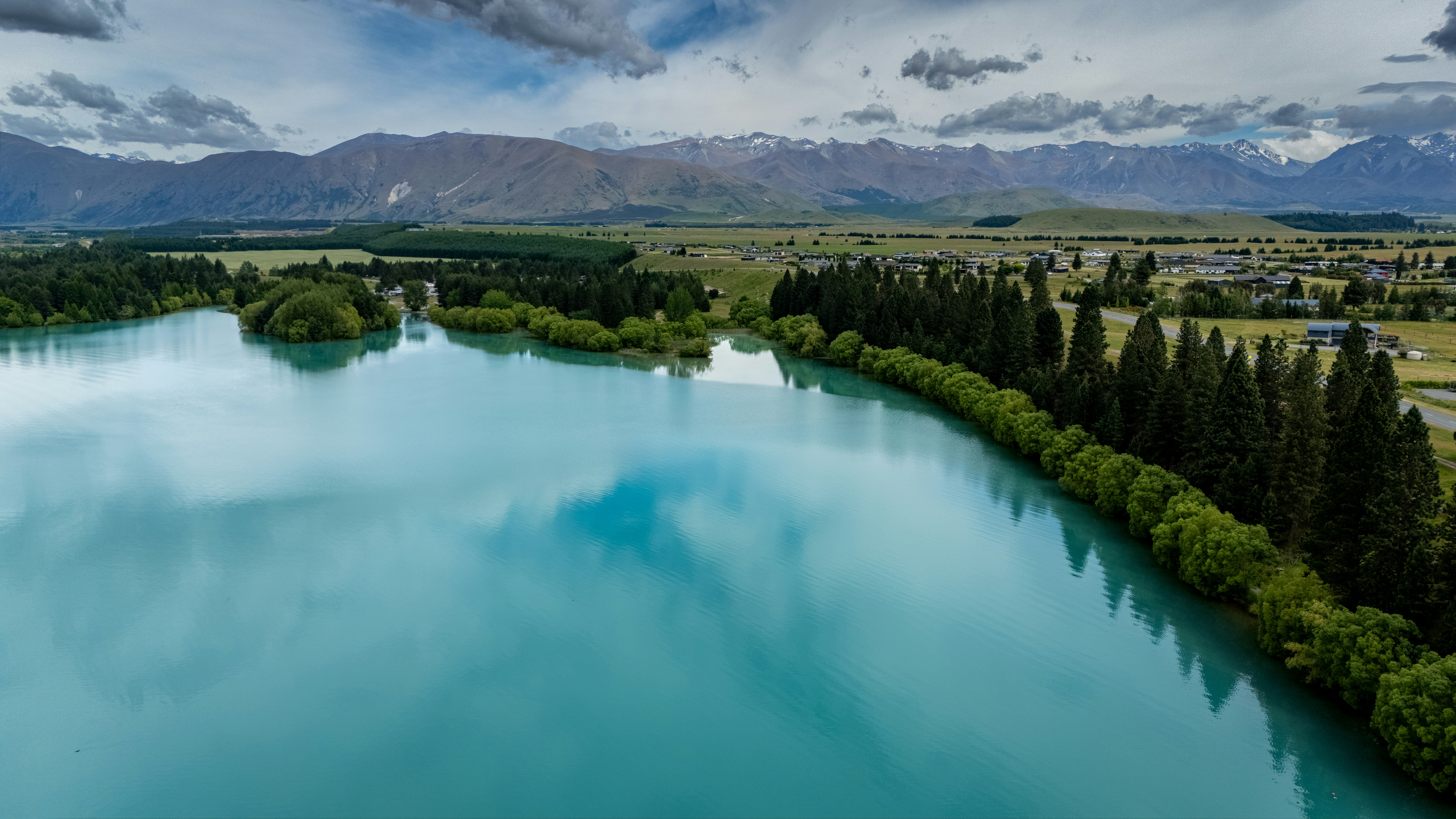 Azure Delta: A Ribbon of Turquoise Water Between Verdant Banks