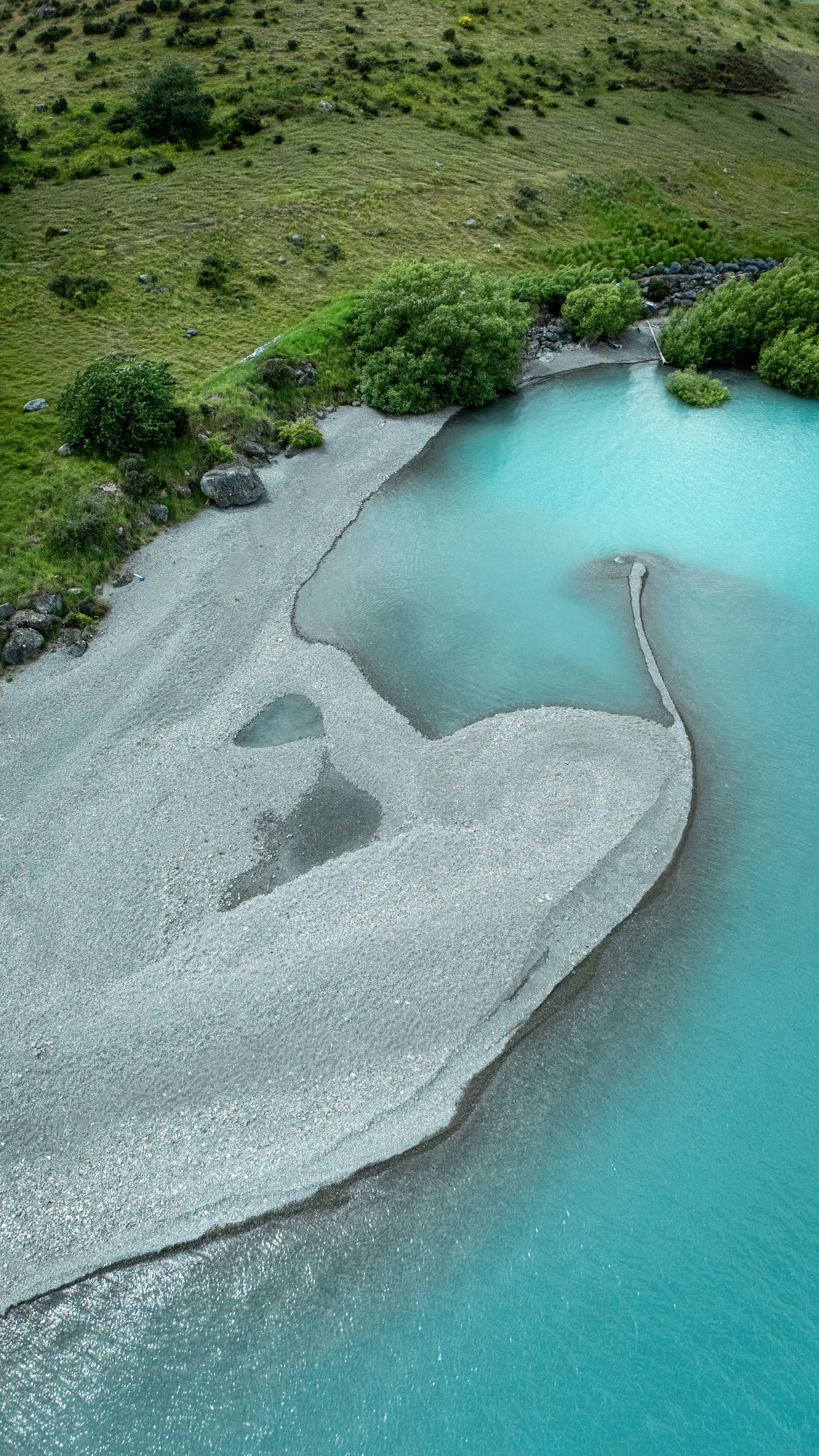 Whispered Lagoon: A Curved Pebble Beach Embracing Turquoise Water
