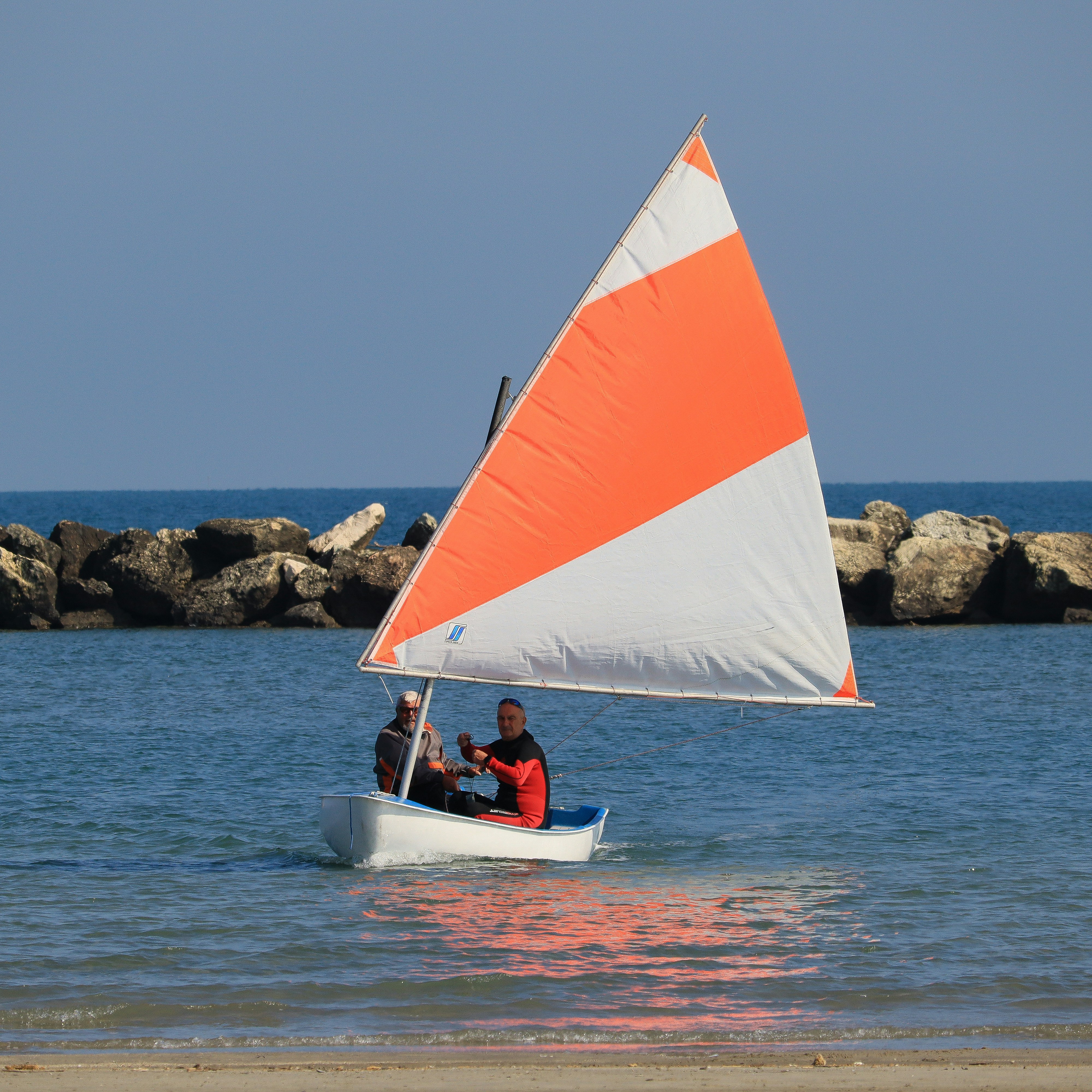 Sailboat at Sea: Bright Triangle of Wind and Water