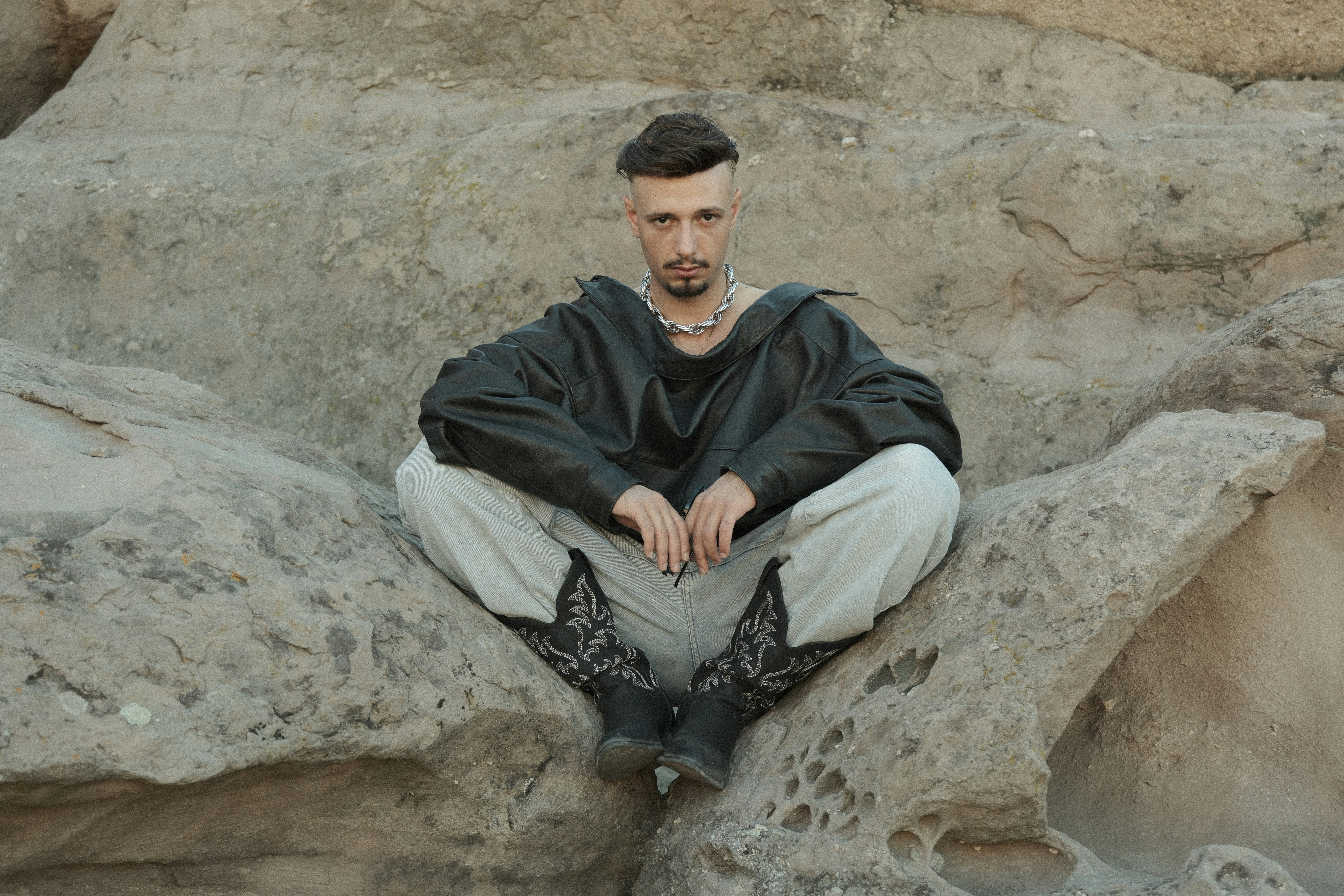 Centered Quiet Strength: A Relaxed Portrait on Weathered Stone