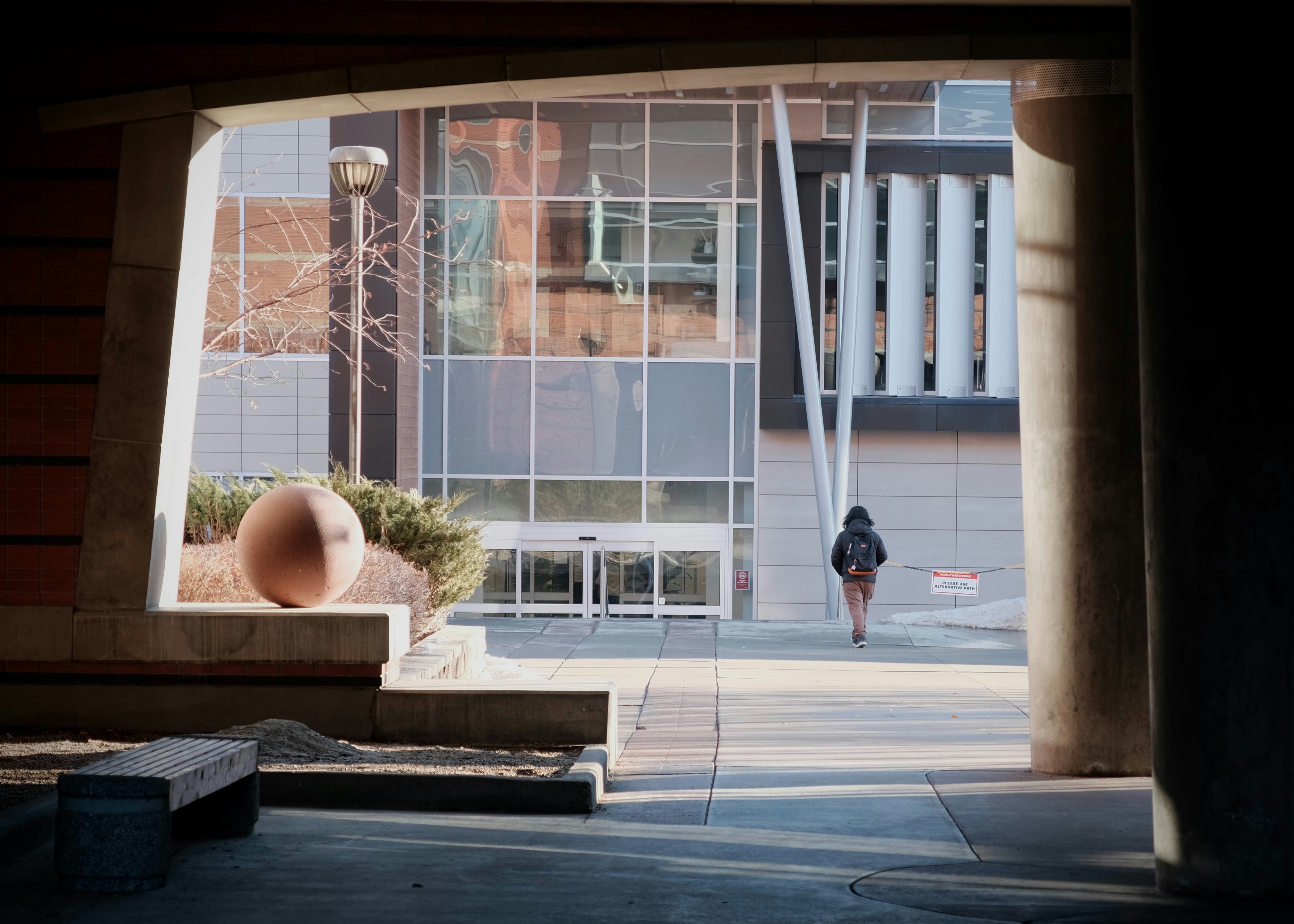 A Quiet Campus Walk Framed by Modern Glass and Concrete