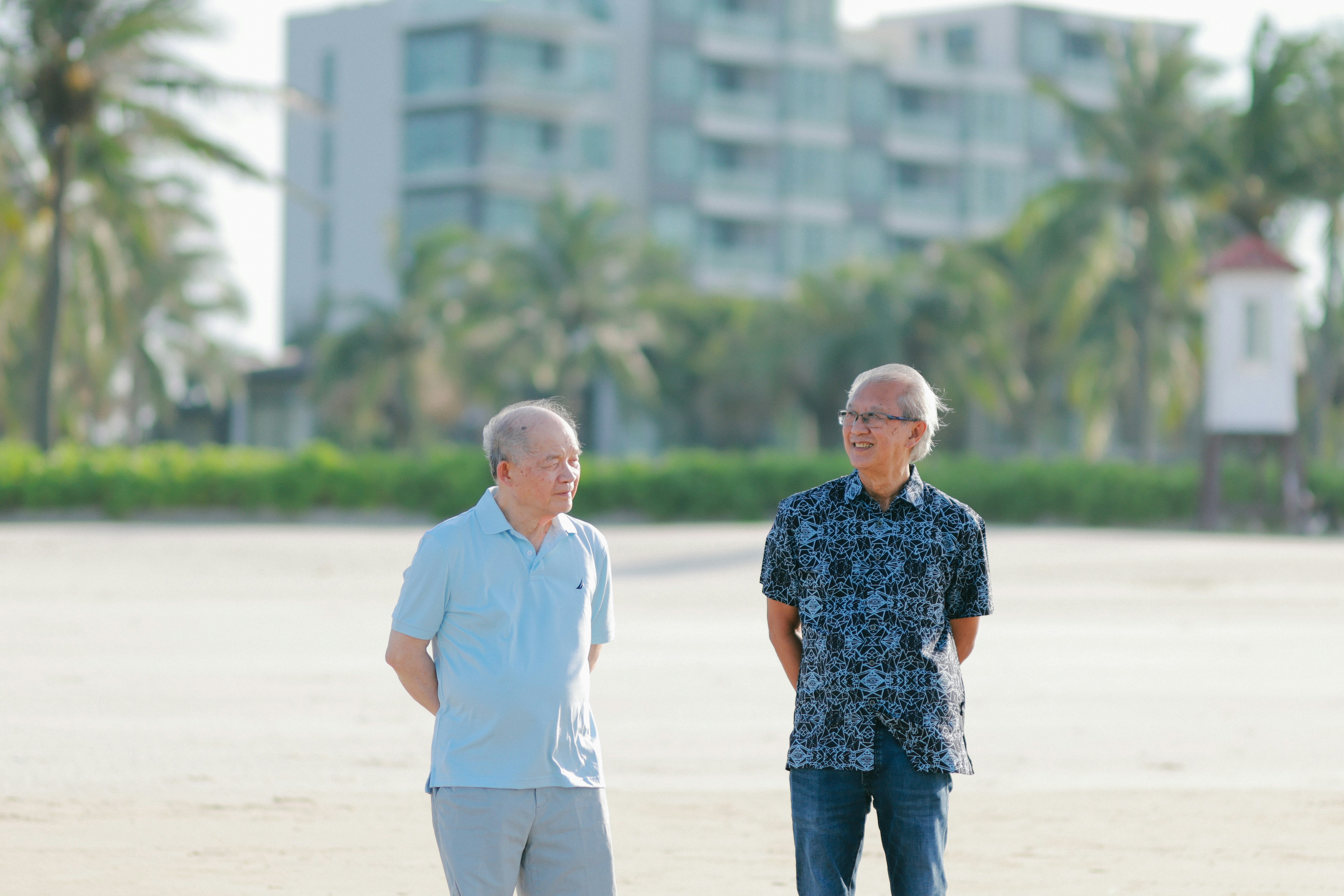 Two Gentlemen in Sunlit Beachscape