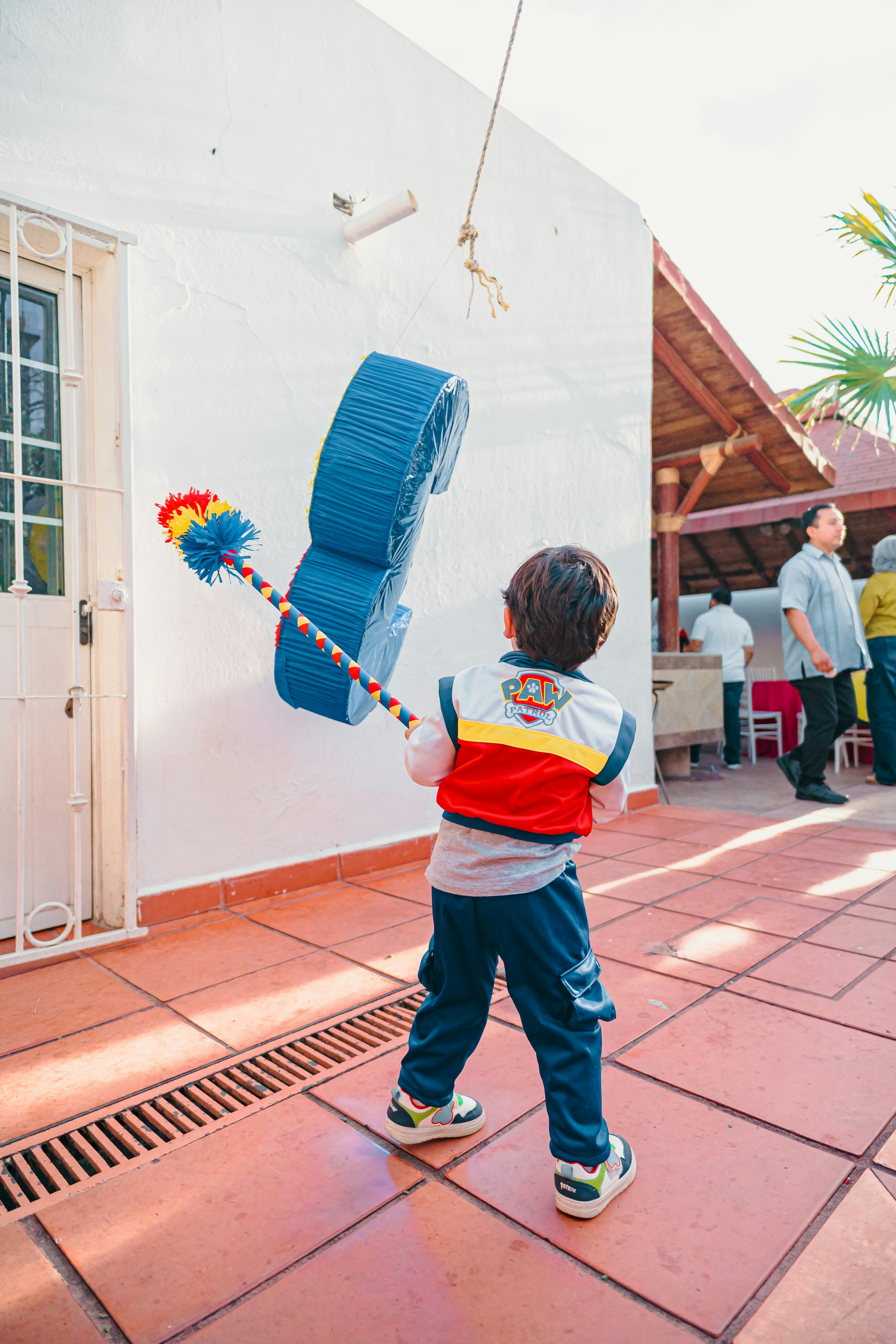 Boy hitting a blue piñata with a stick photo – Free Family Image on ...