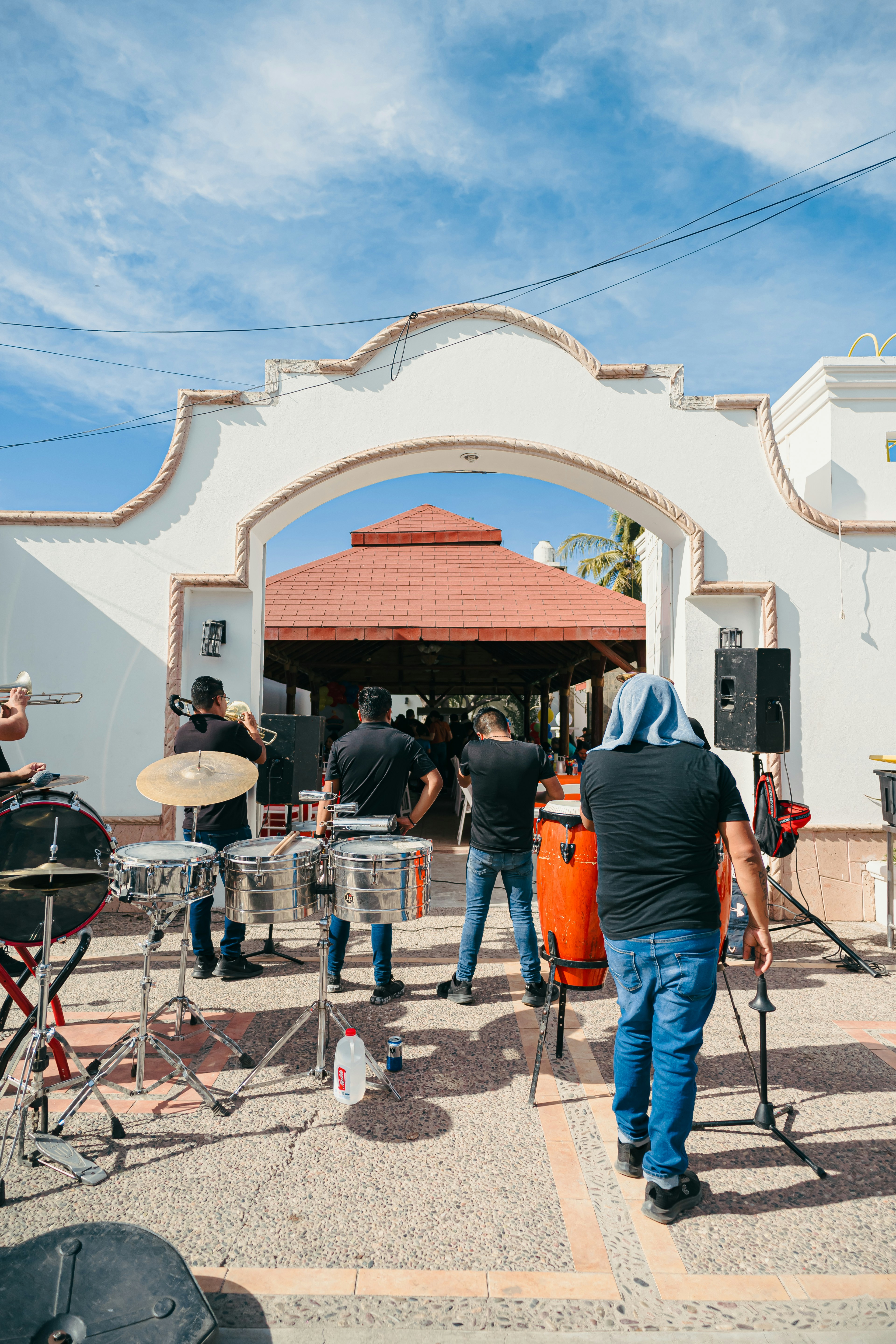Open-Air Rhythm: Musicians energize a sunlit courtyard stage