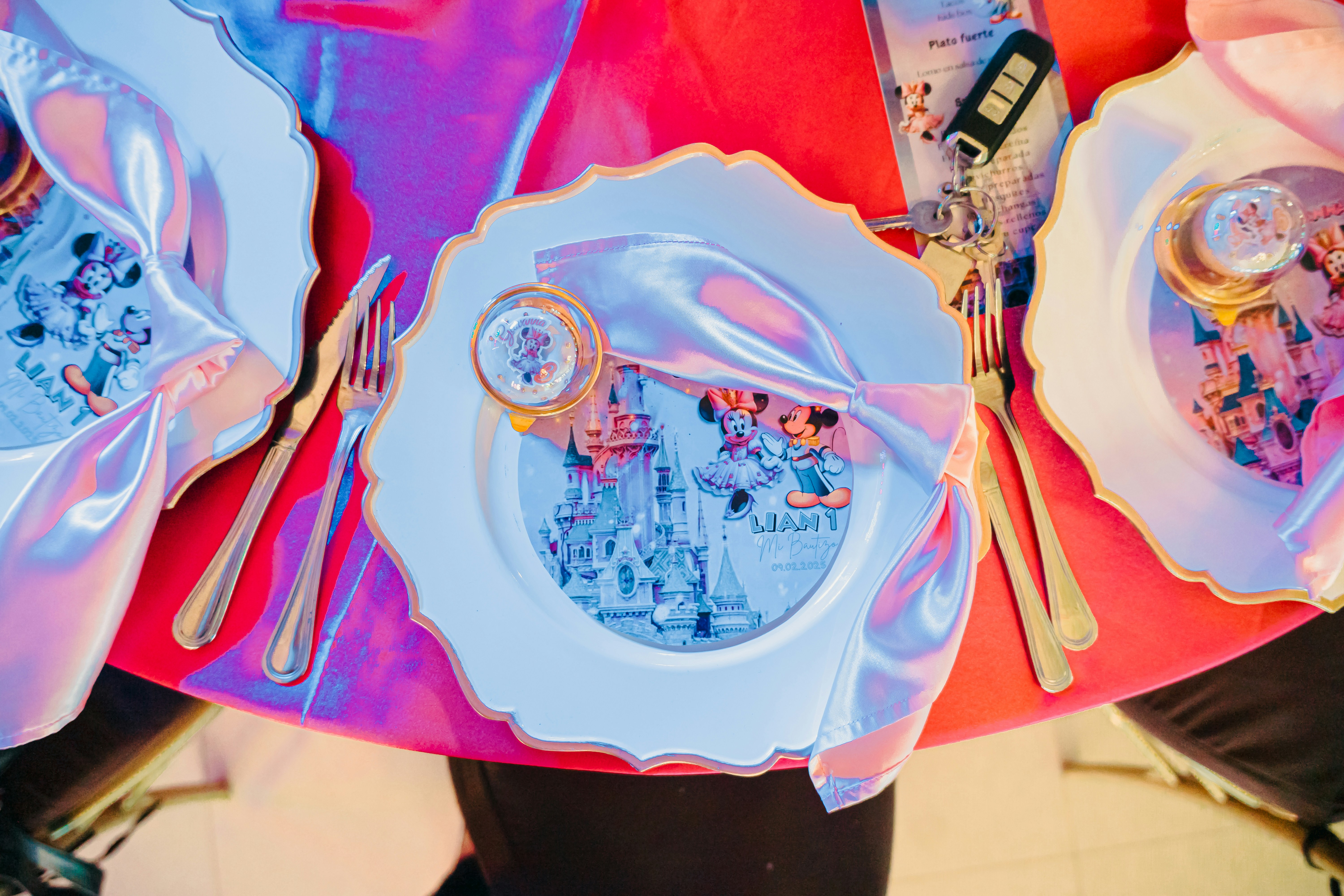 Table Setting in Colorful Gala: Plates, Napkins, and Cutlery Framed by a Vibrant Backdrop