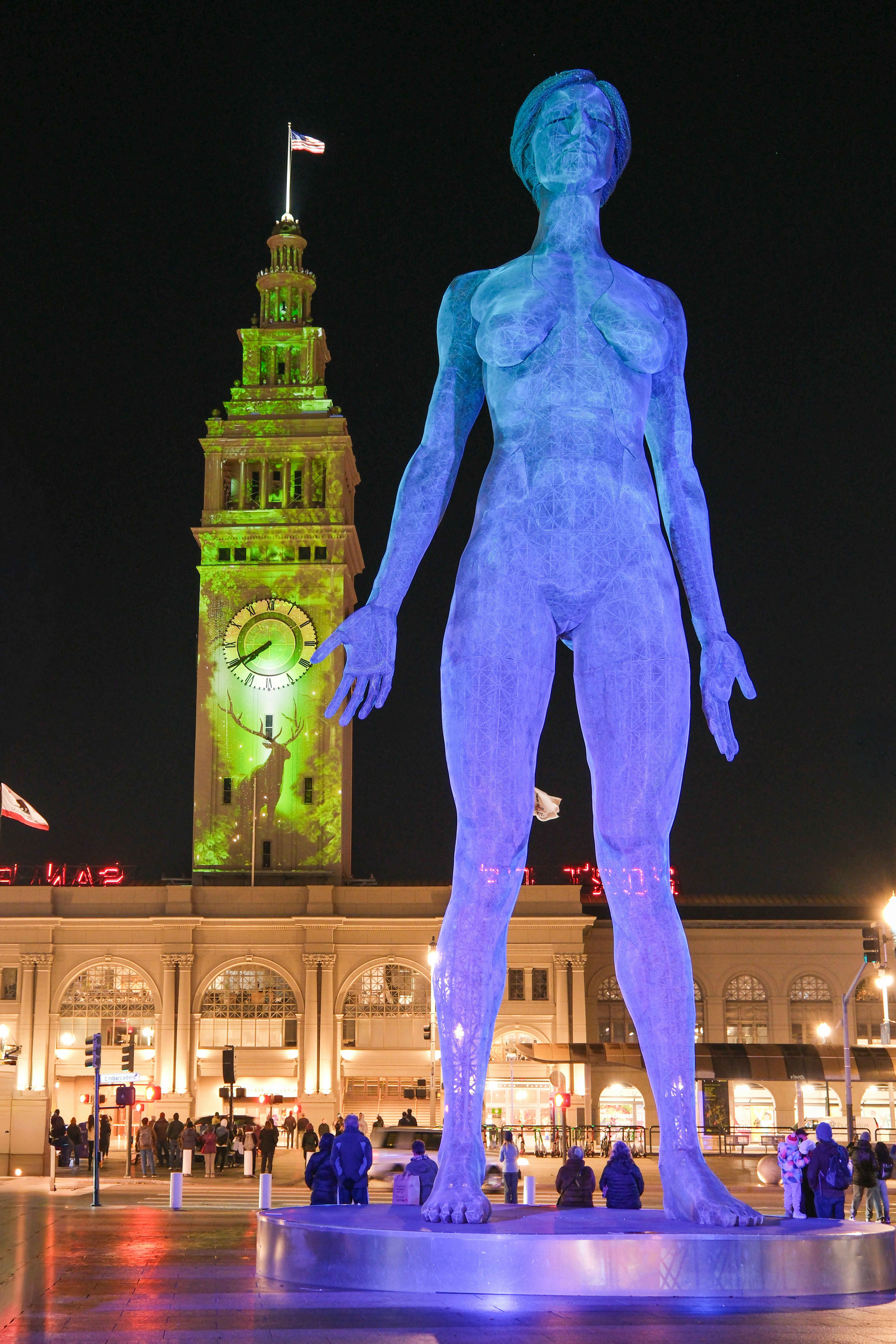 Blue Giant: Night Portrait of a Neon-Sculpted Figure Before a Clocktower