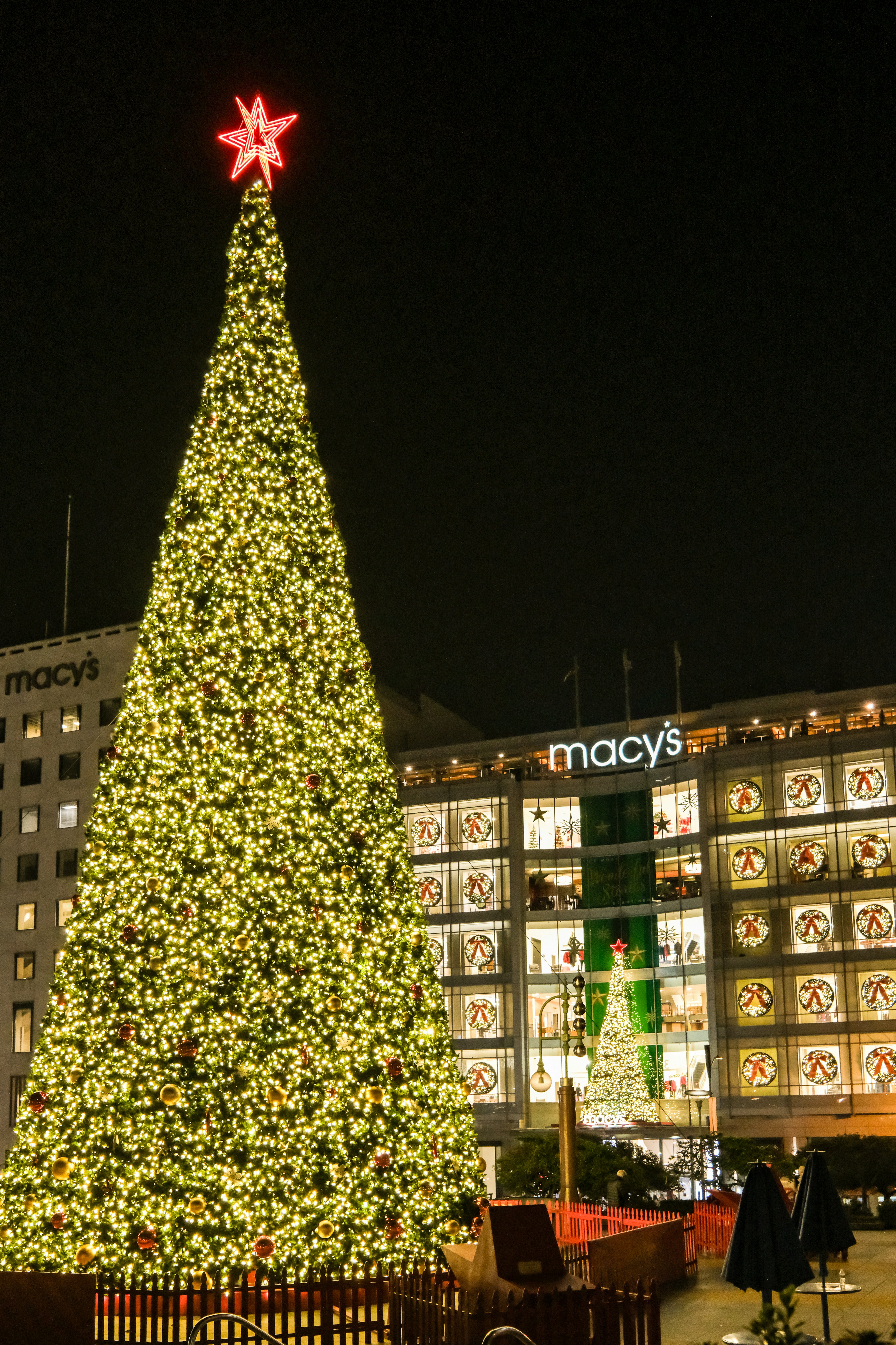 Star atop the illuminated Christmas tree in front of Macy's