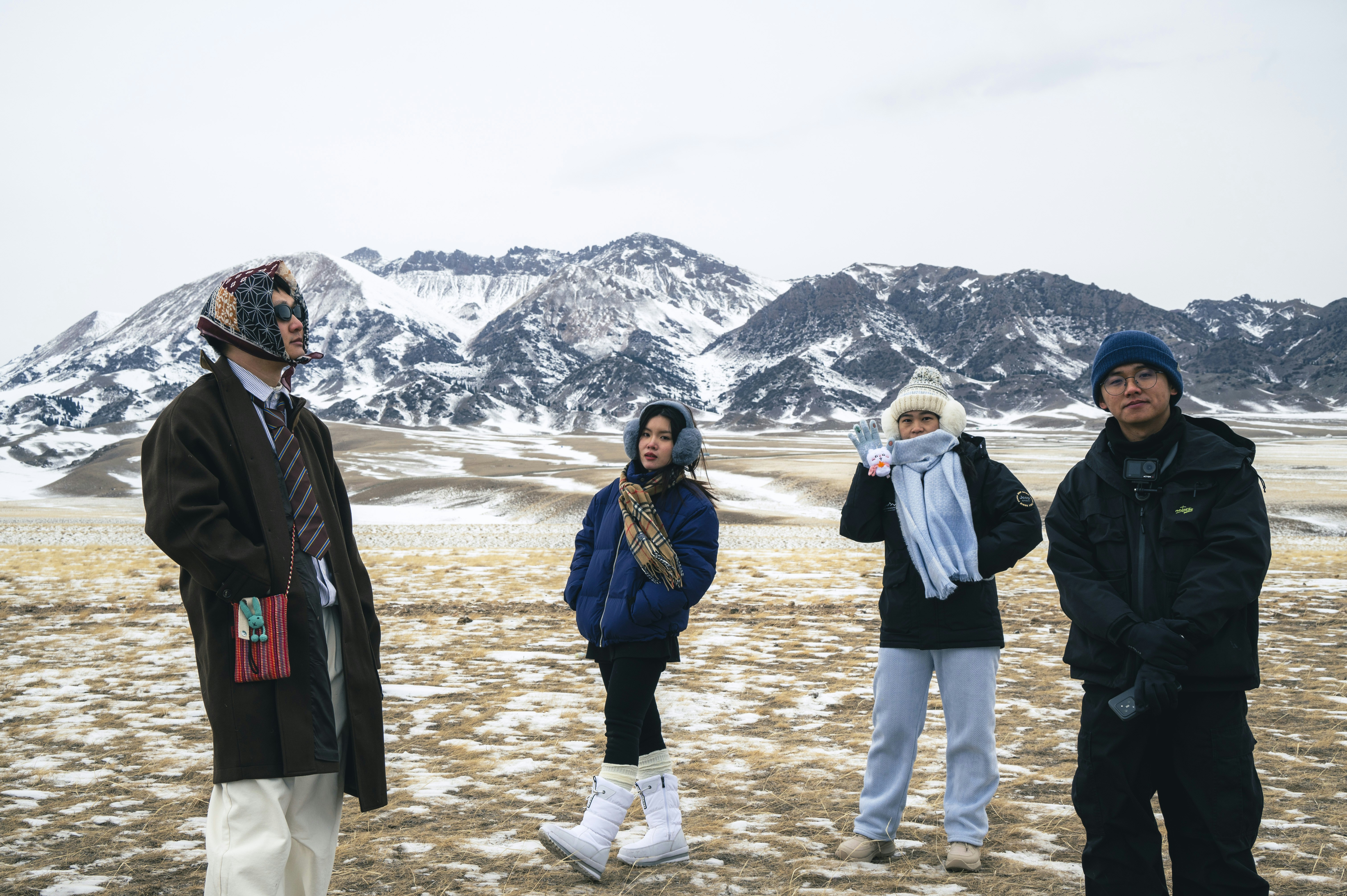 Winter Stillness: Four Travelers in a Snow-Dusted Basin