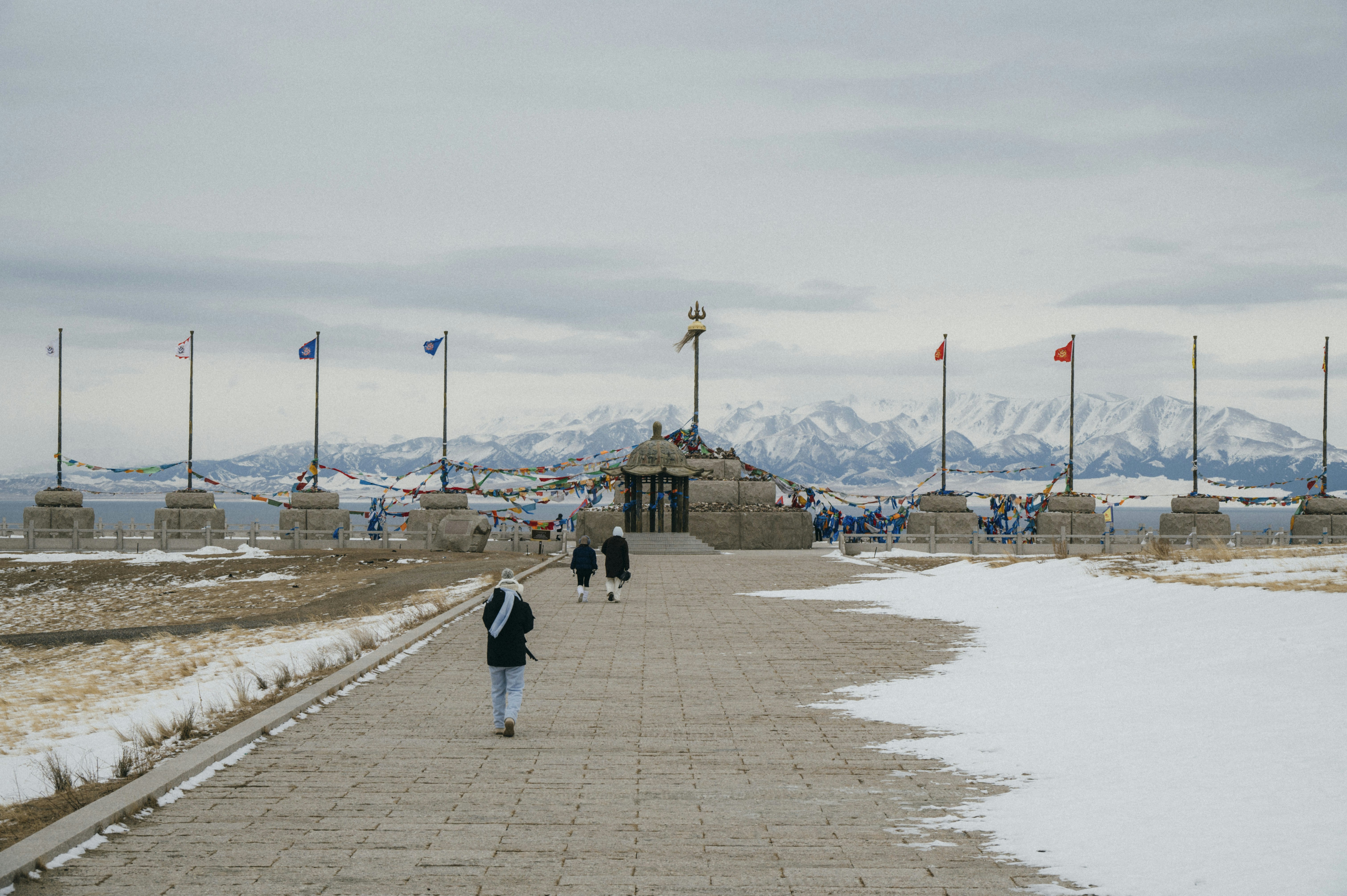 People walking on a path with flags and mountains. photo – Free Lake ...