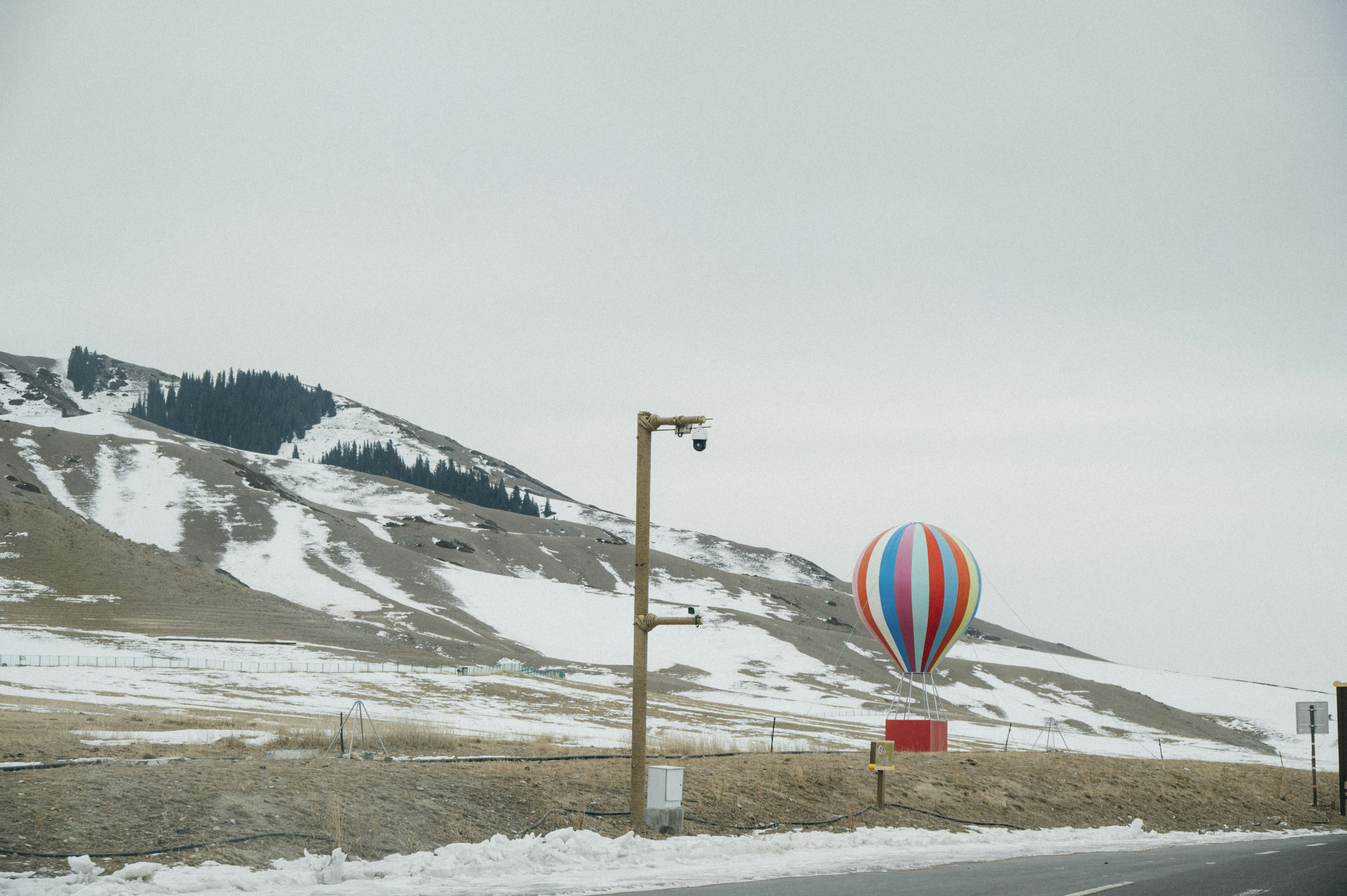 Strawberry Balloon over Snow-dusted Hills