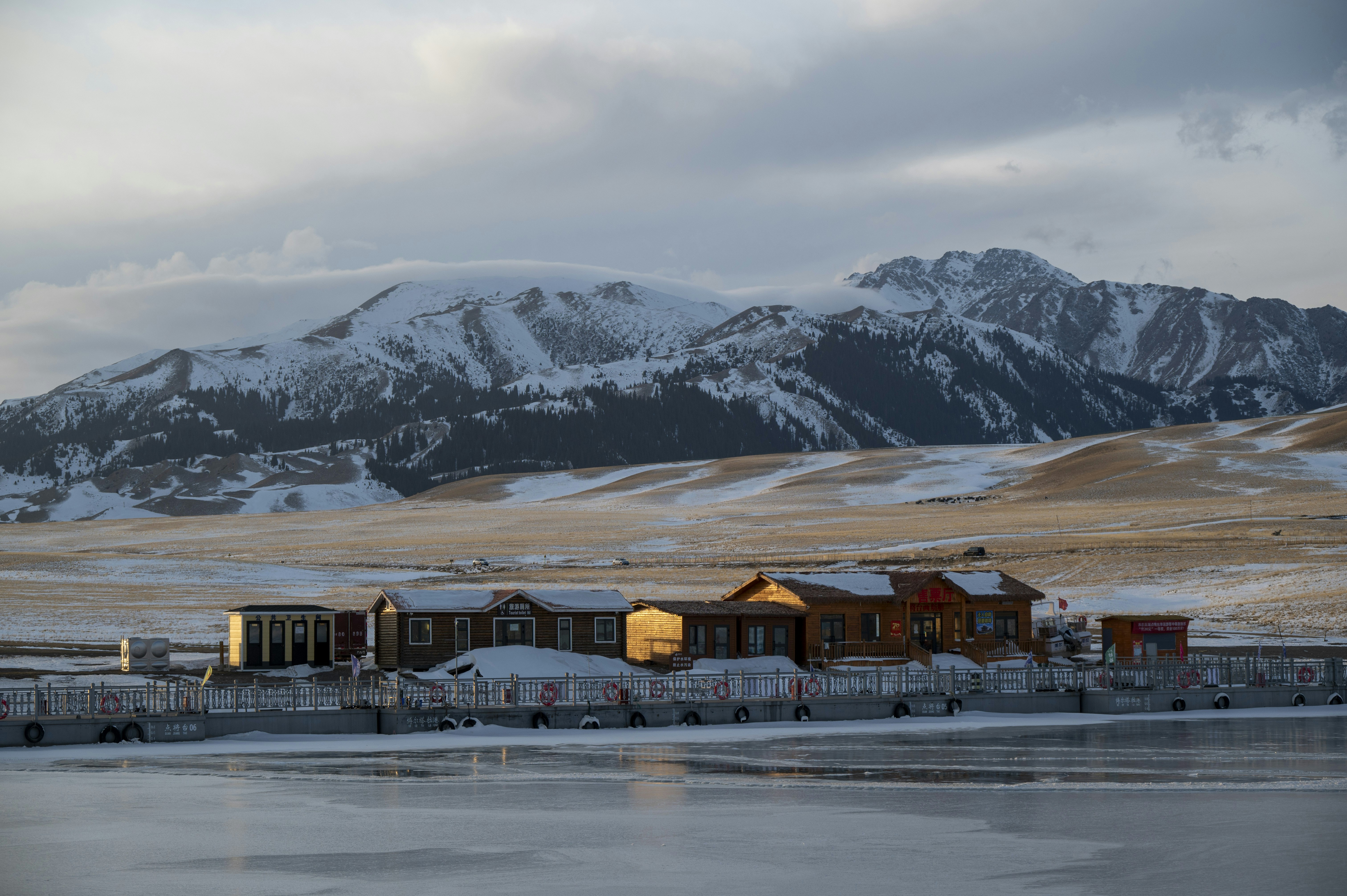 Snowbound Village by the Frozen Lake at Dusk