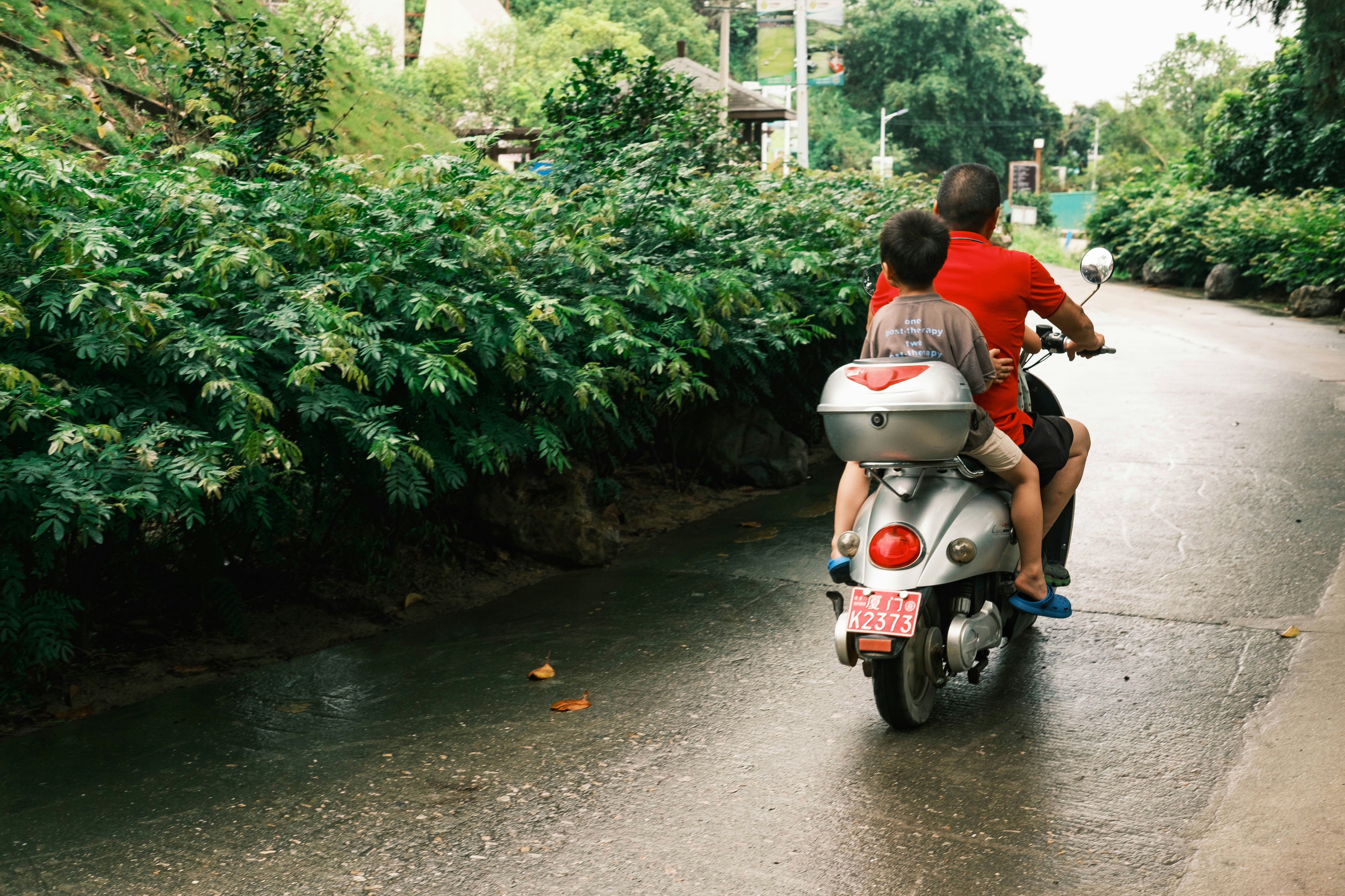 Couple on a Scooter in a Lush Riverside Lane