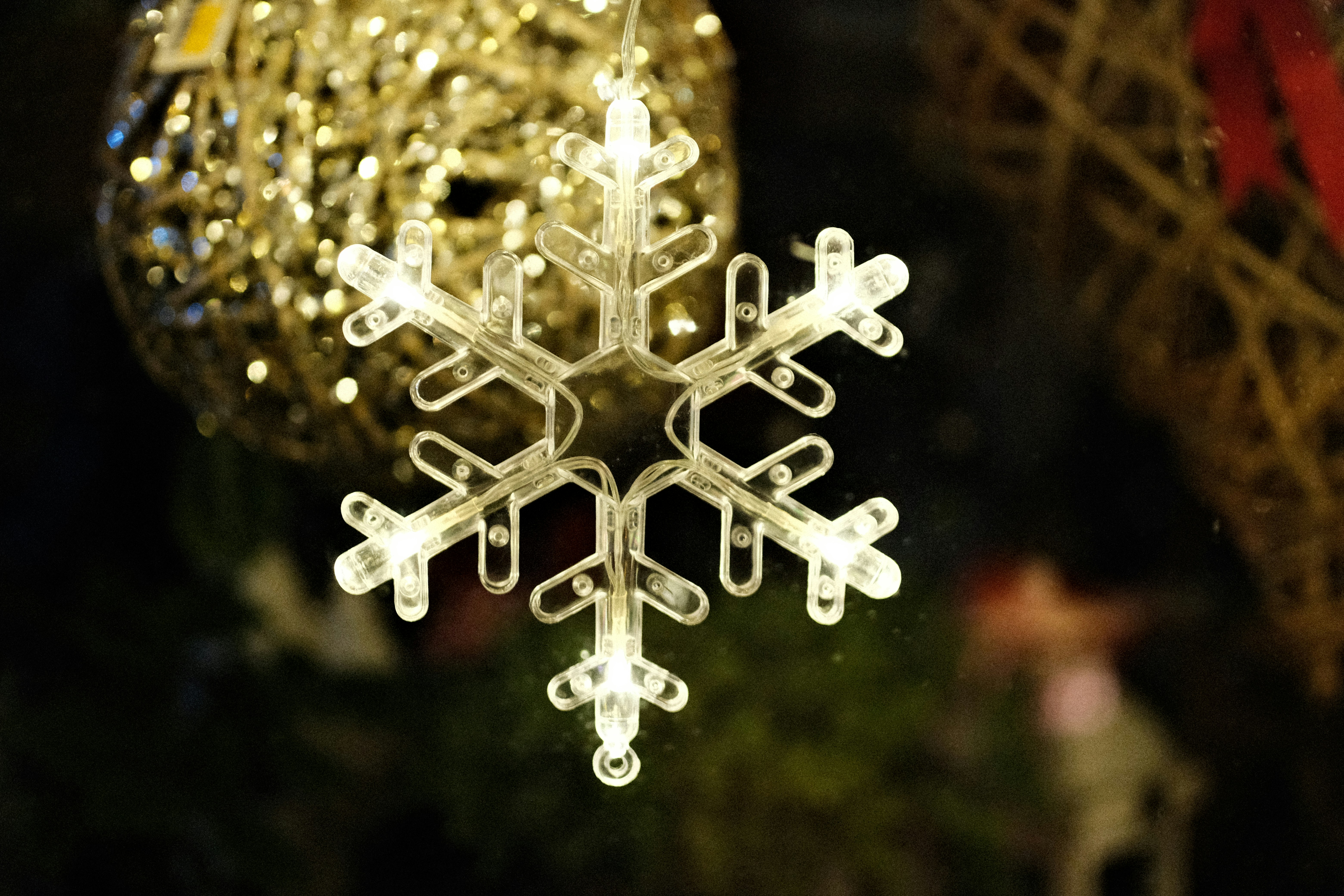 Glowing Snowflake Ornament in Warm Holiday Blur