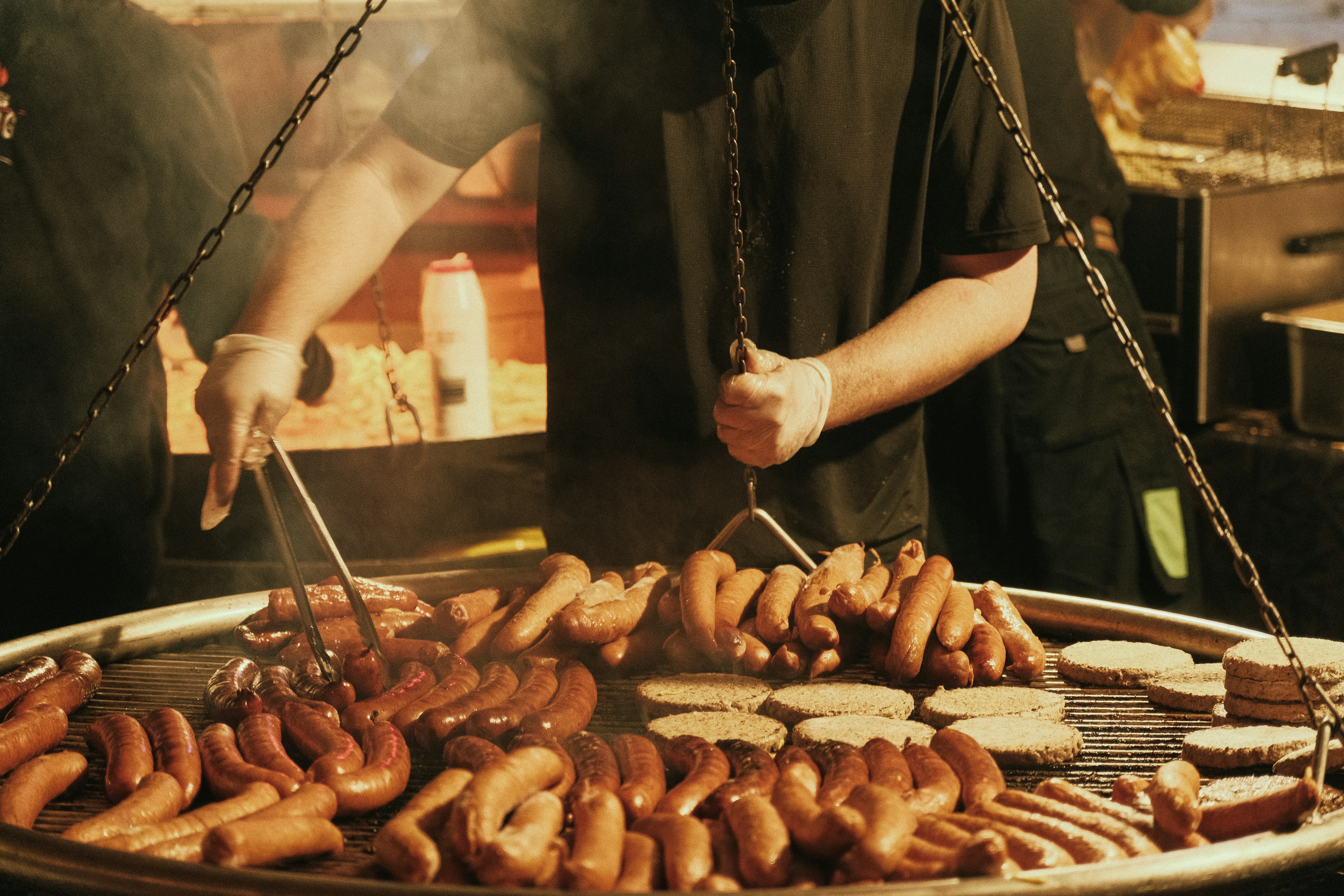 Grill Master at Dawn: Sausages Sizzle Over Open Flames