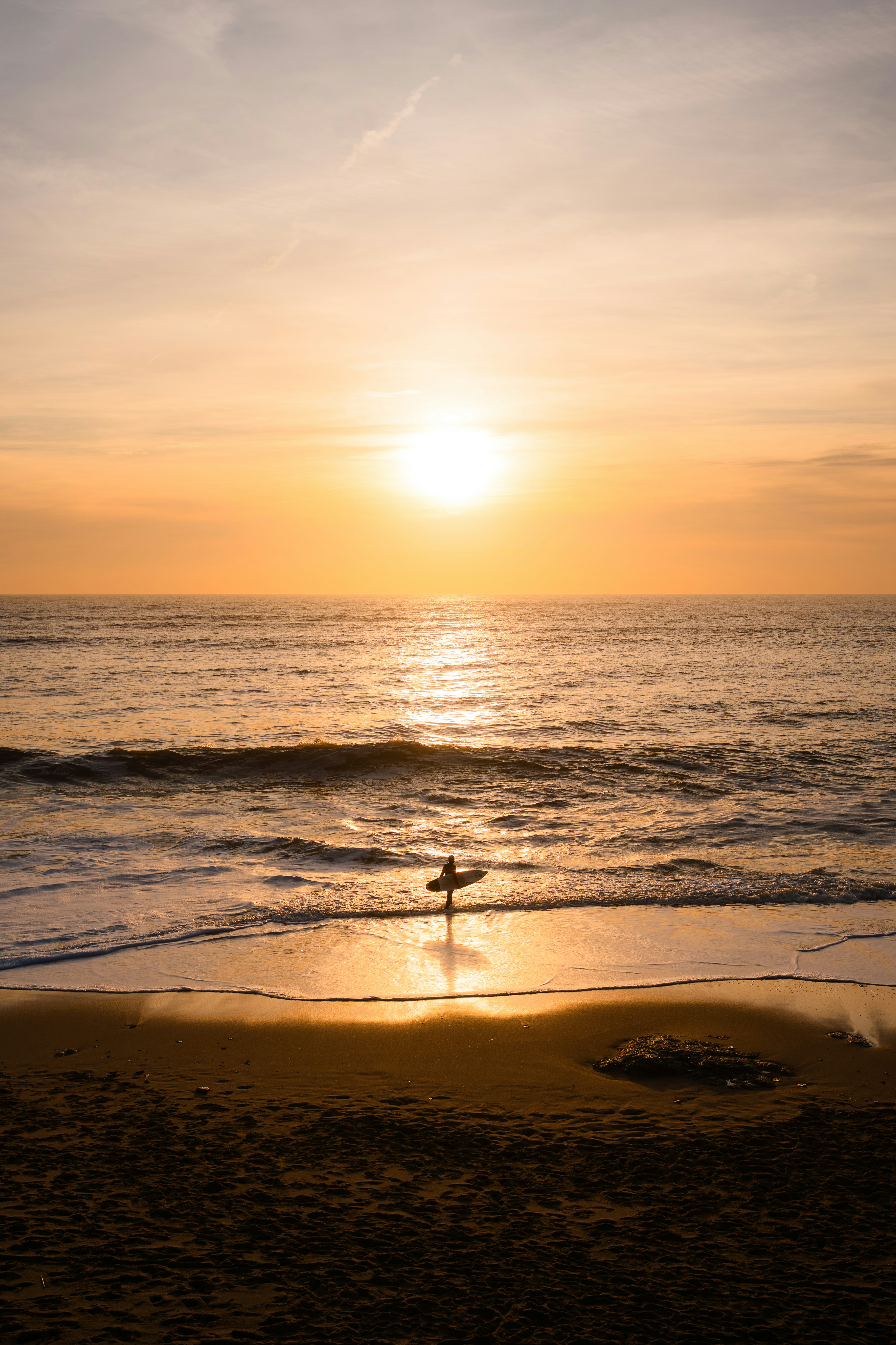 Silhouette of a Surfer at the Sunset Shore