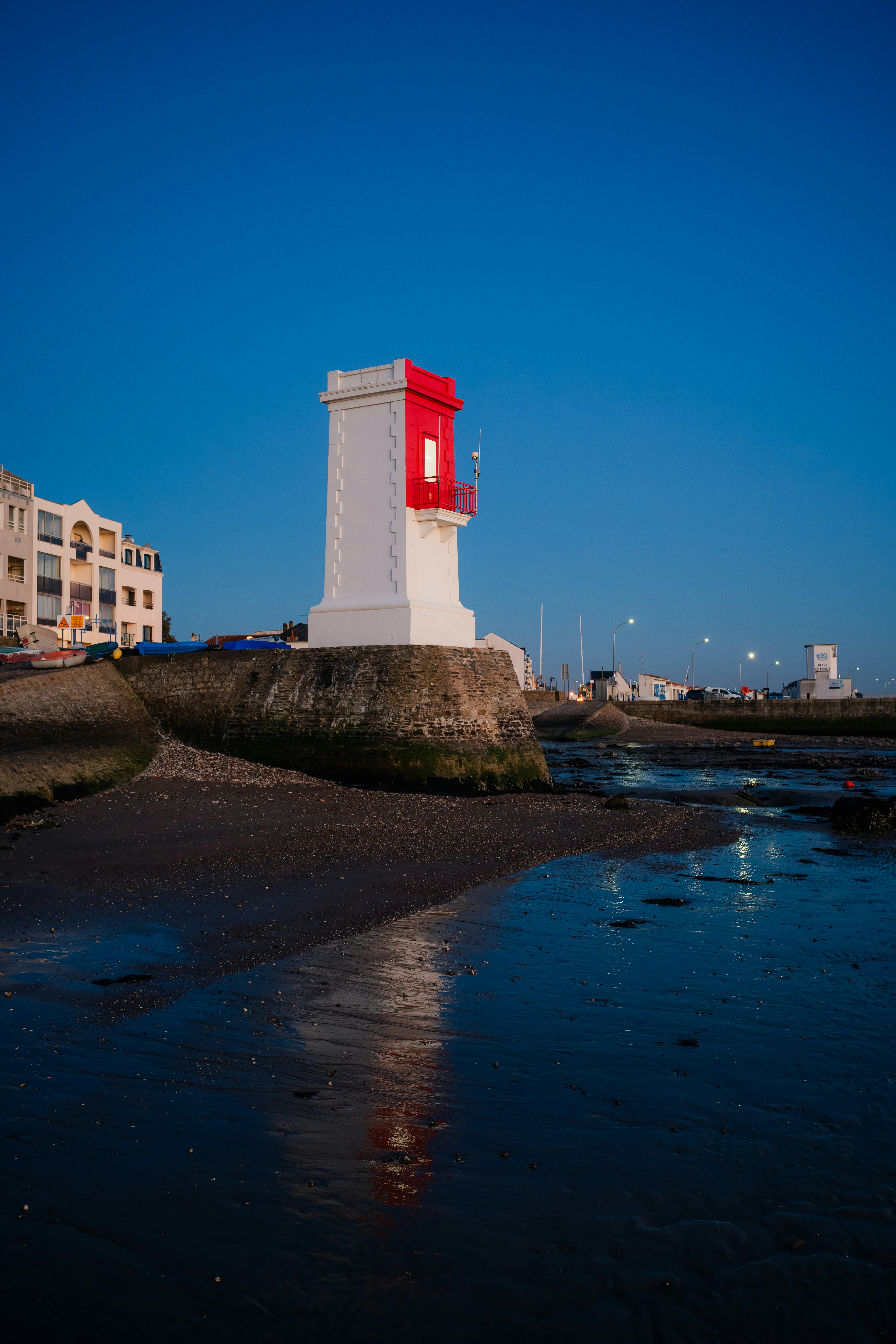Lighthouse on the Tide: White Tower with Red Lantern at Dusk