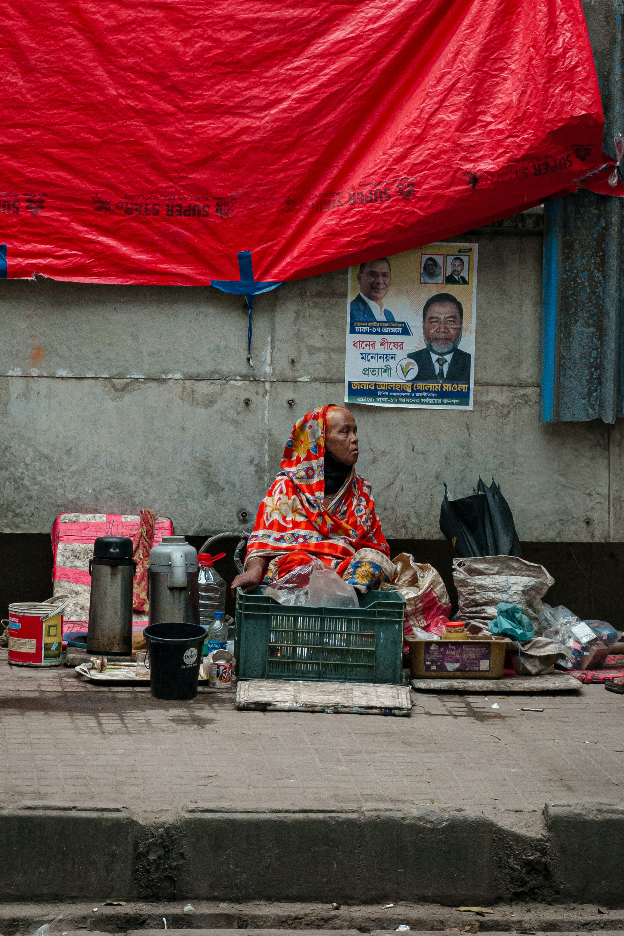 Market-Side Portrait Under a Red Tarpaulin