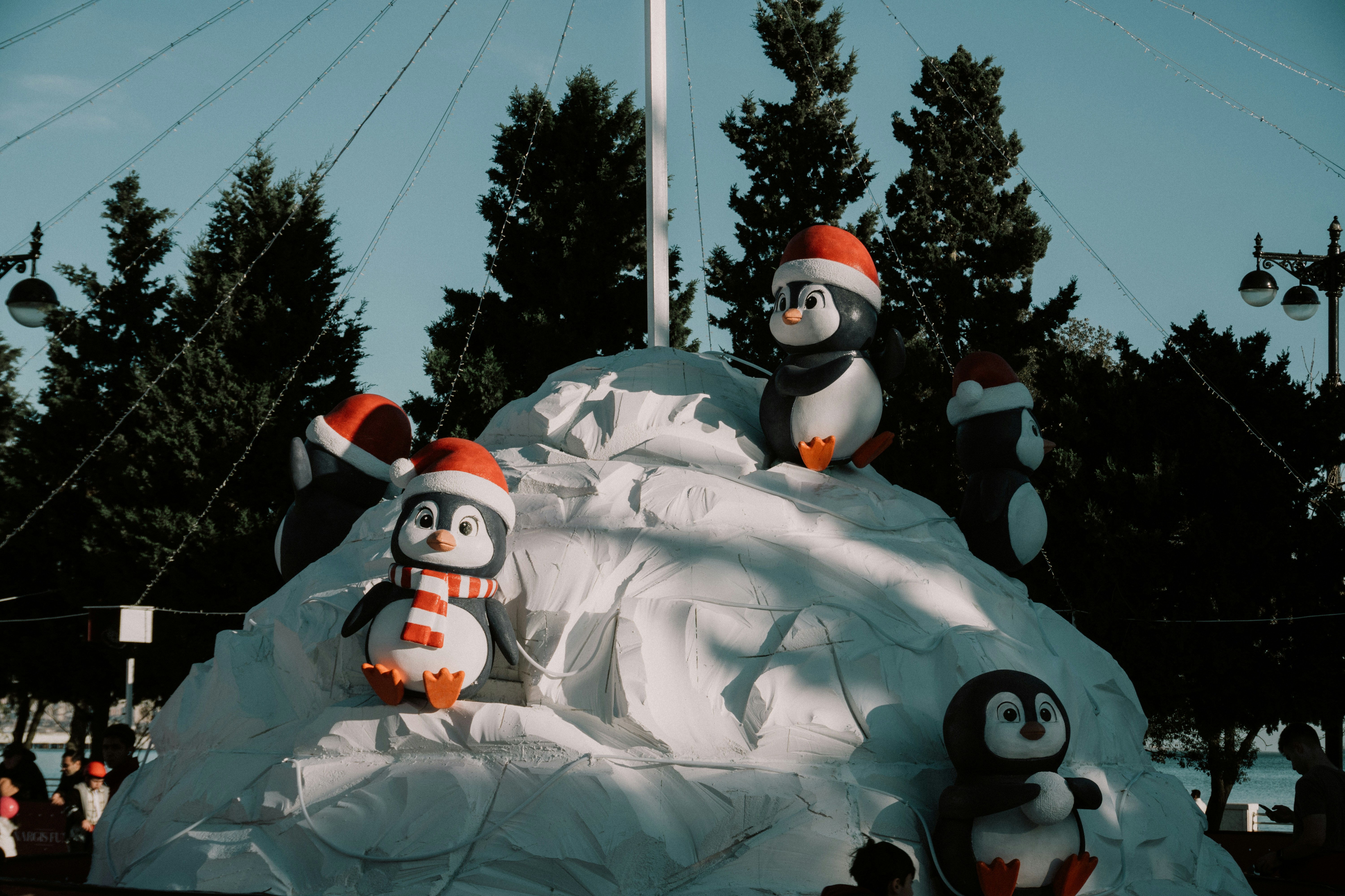 Snowy Penguin Parade Under Winter Lights
