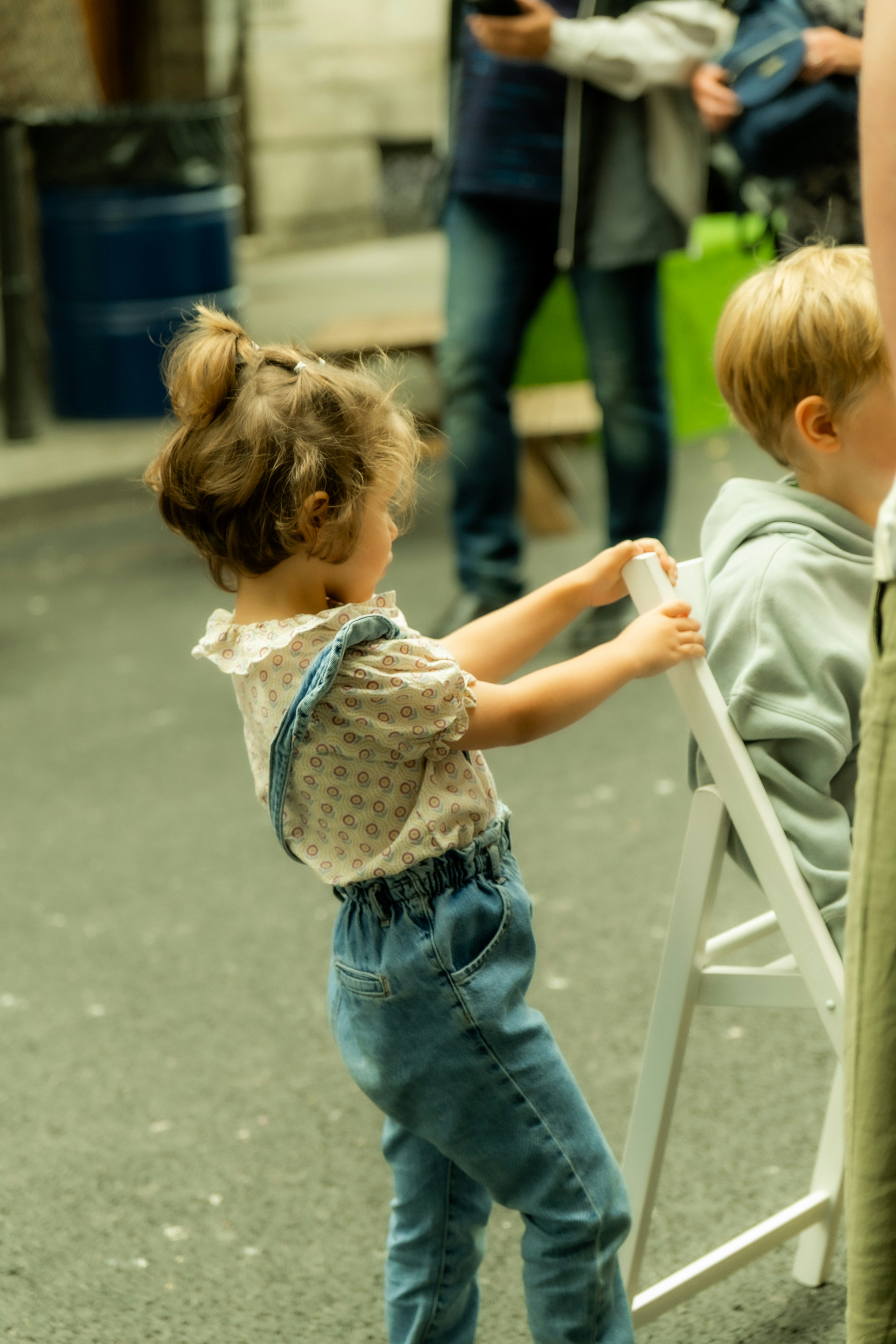 Child at Play: A Moment of Help by the White Chair