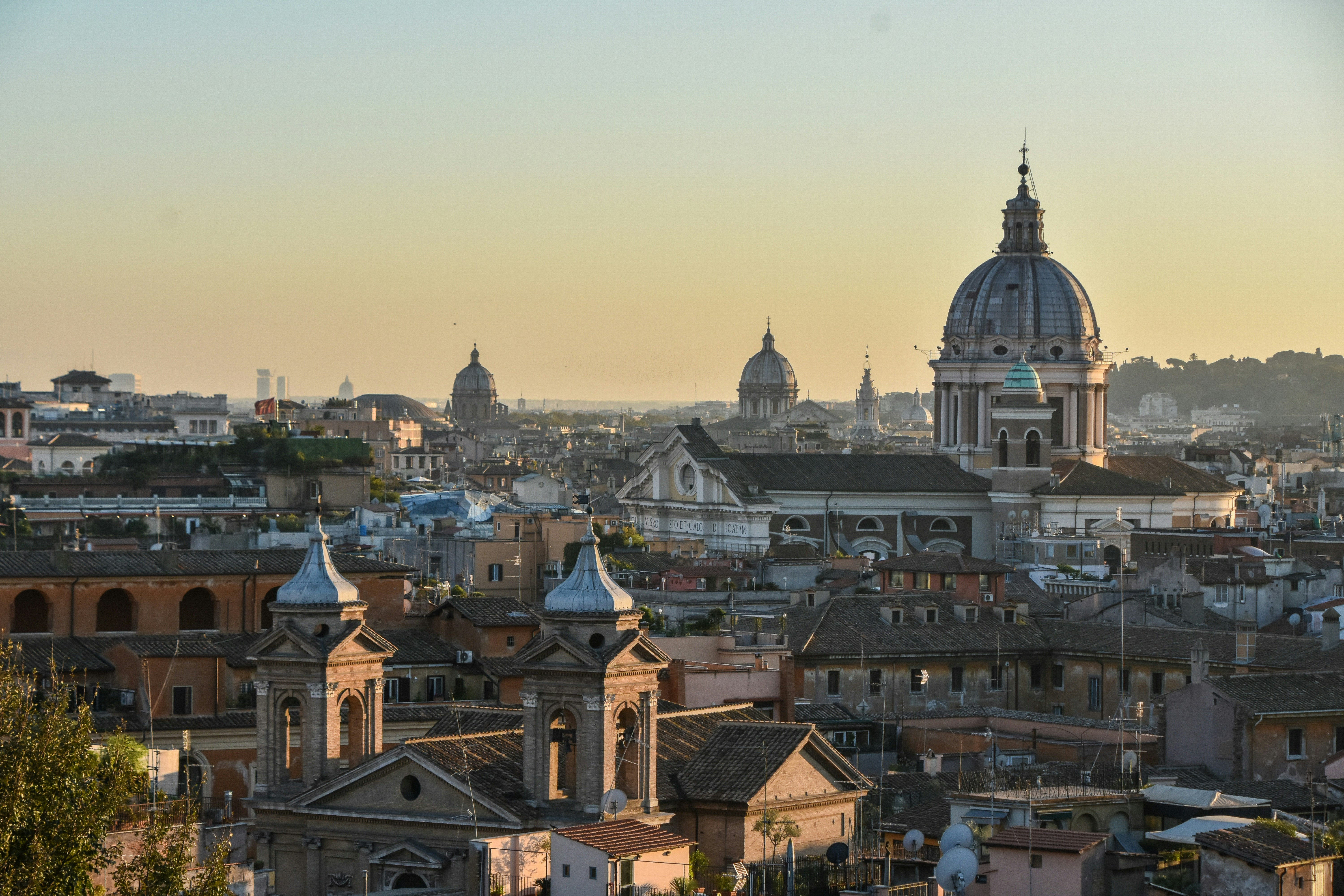 Rooftops and domes of rome at sunsetThe Quiet Atlas