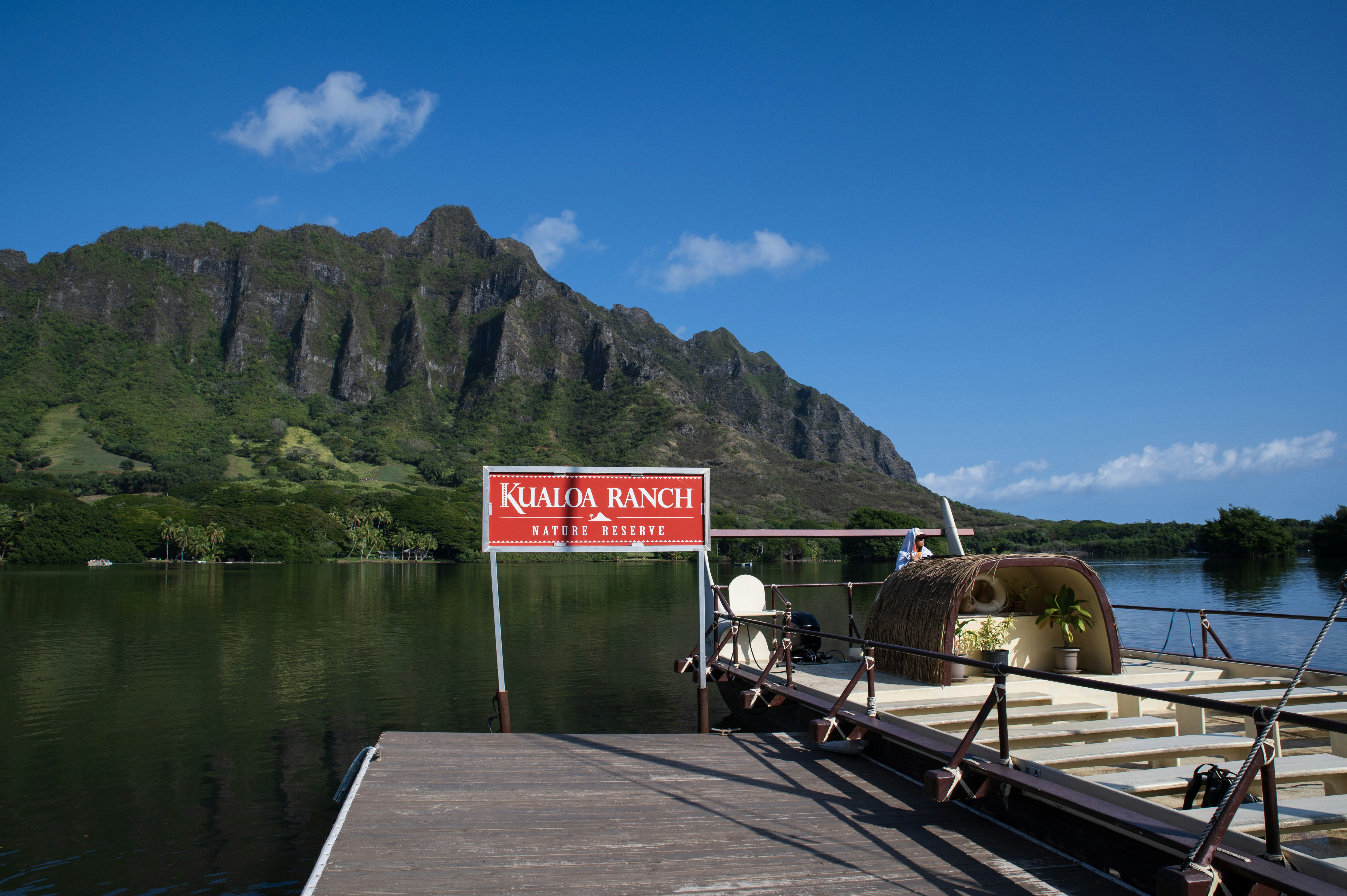 Kualoa Sign Overlooking the Quiet Pier Toward the Mountain