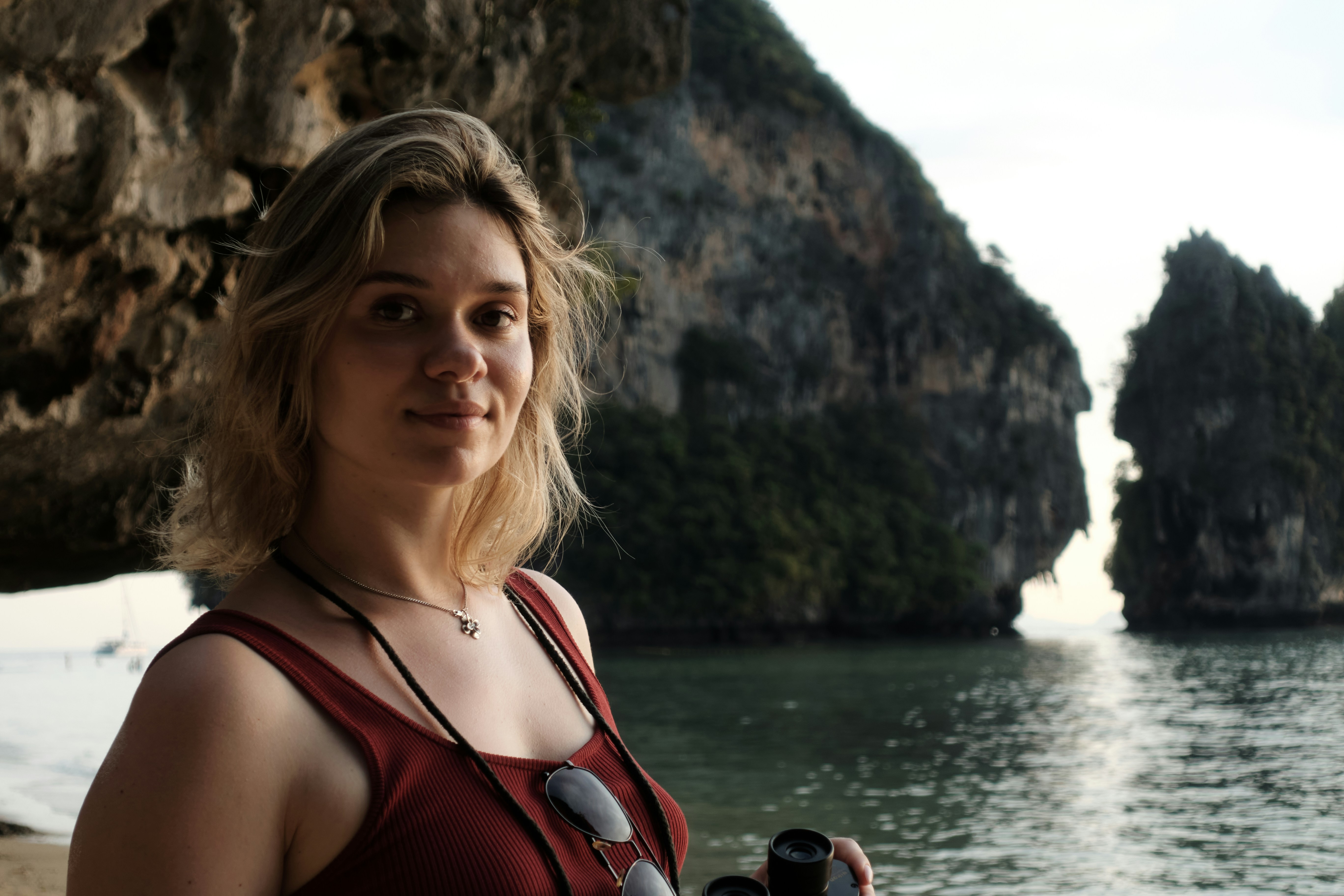 Portrait at the Gate: A Solo Traveler Against Sea Cliffs