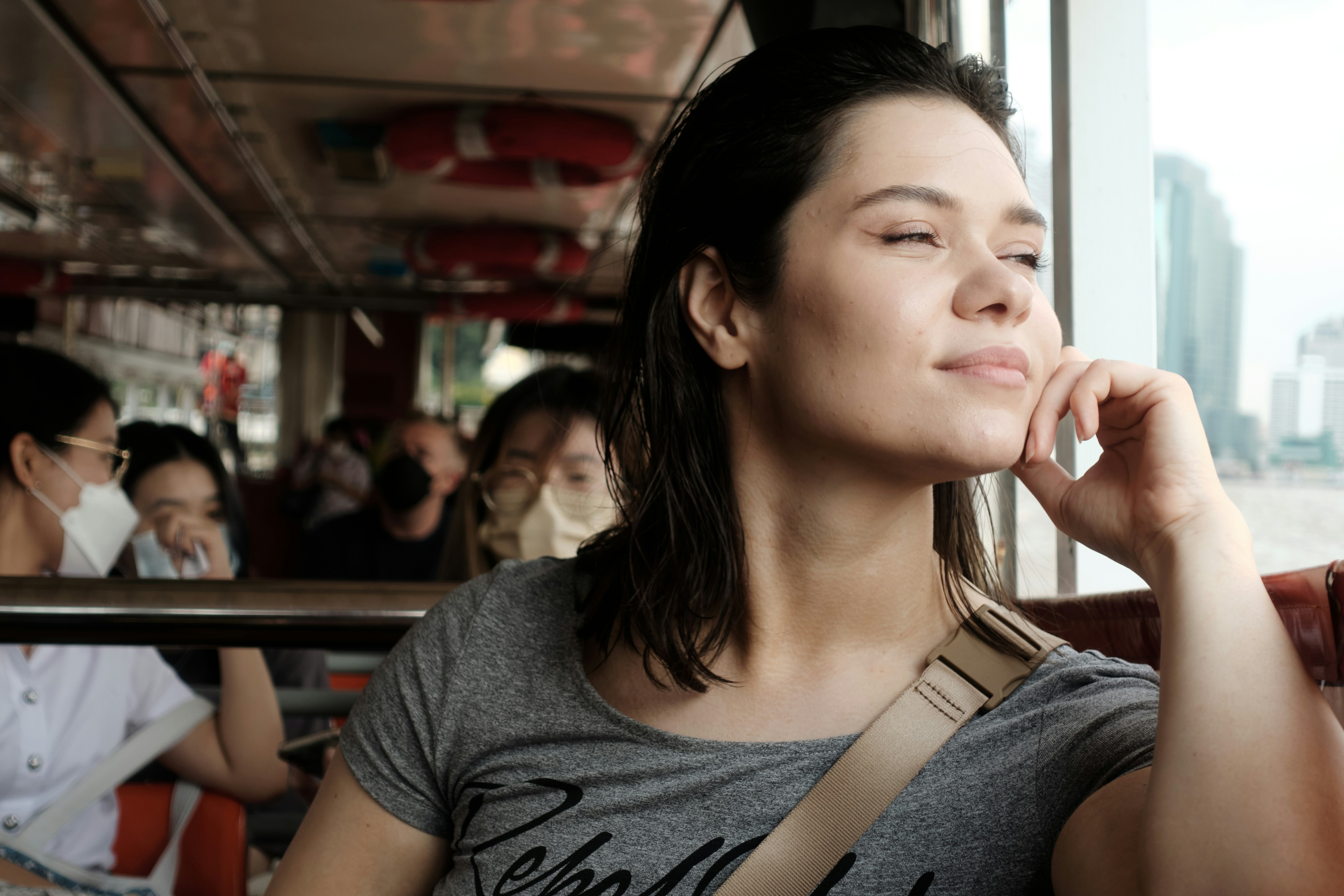 Contemplative Moment on a City Ferry