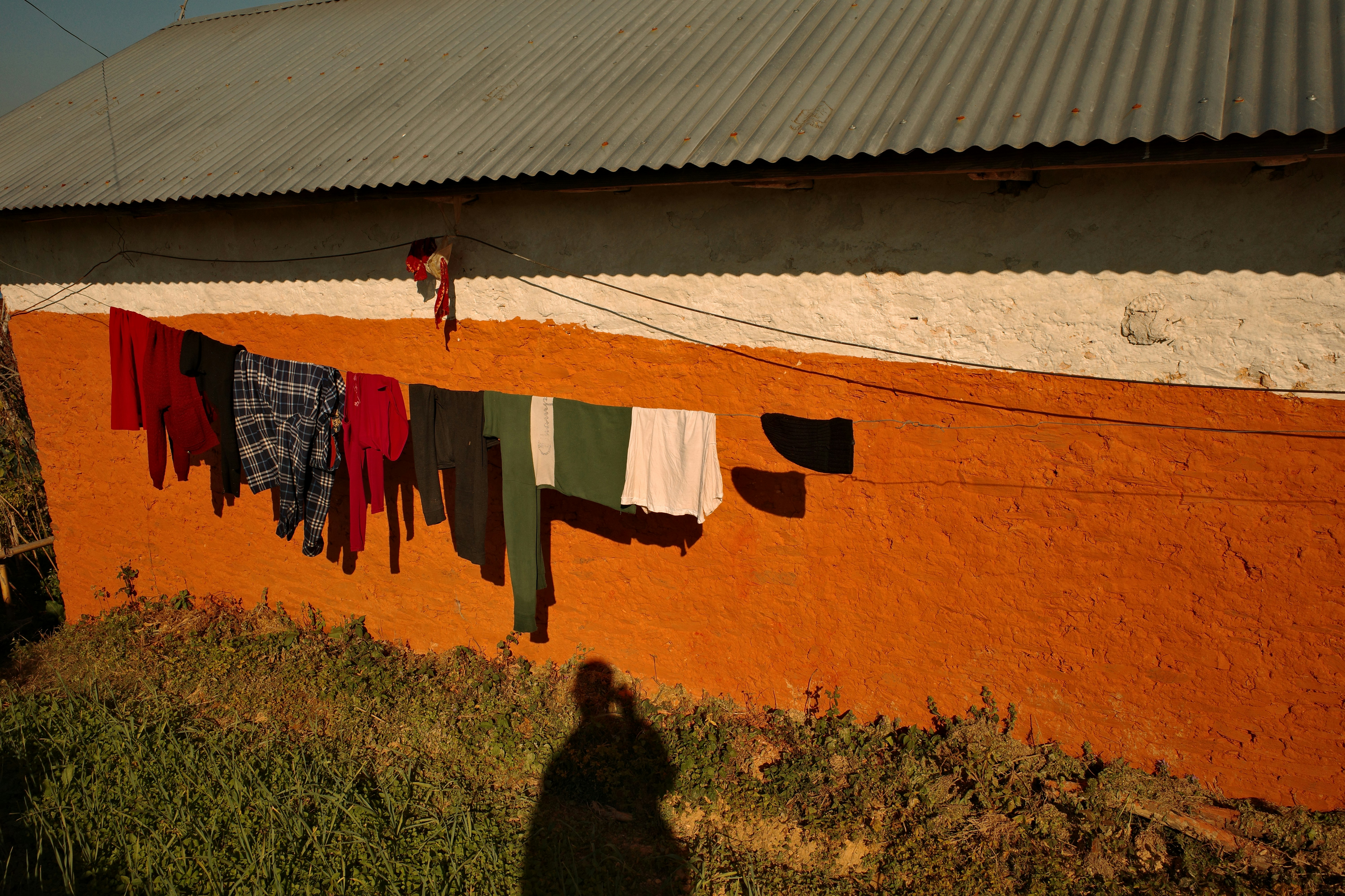 Laundry Line Across an Orange Wall in Bright Afternoon Light