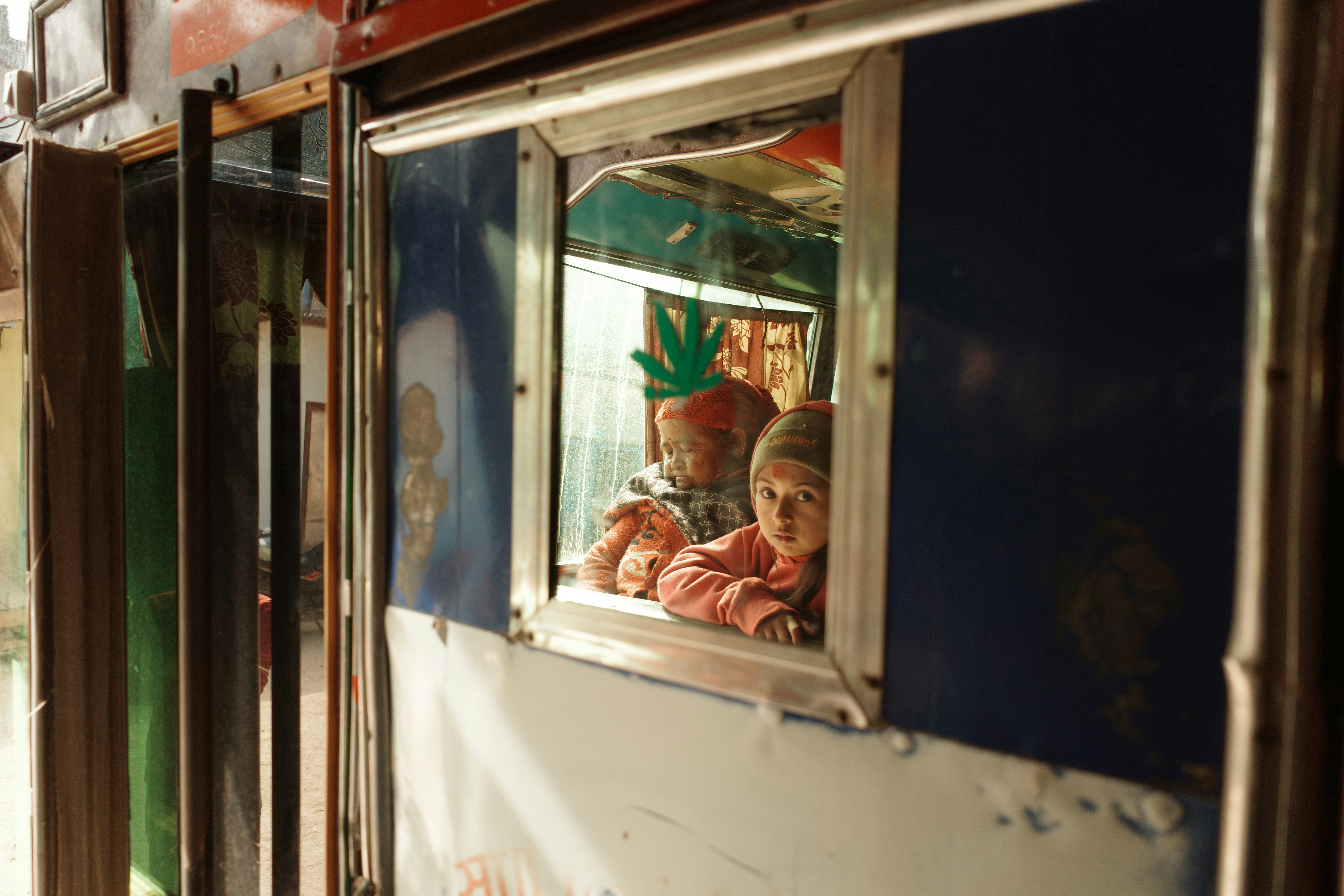 A Child Above the Window: Quiet Hope Through a Train Window