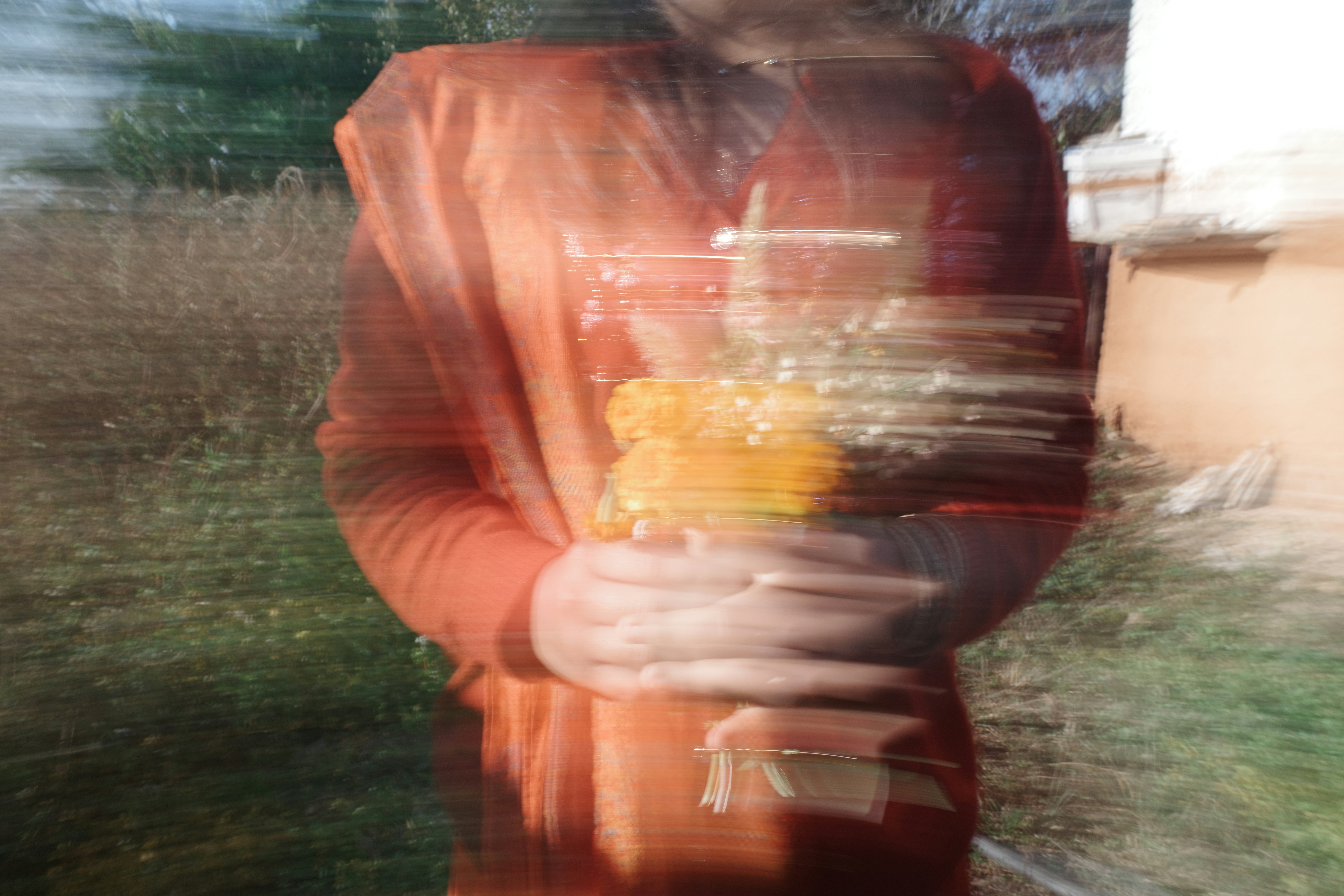 Blurred Reflection: A Person Unfolding a Snack in a Glassy Silhouette