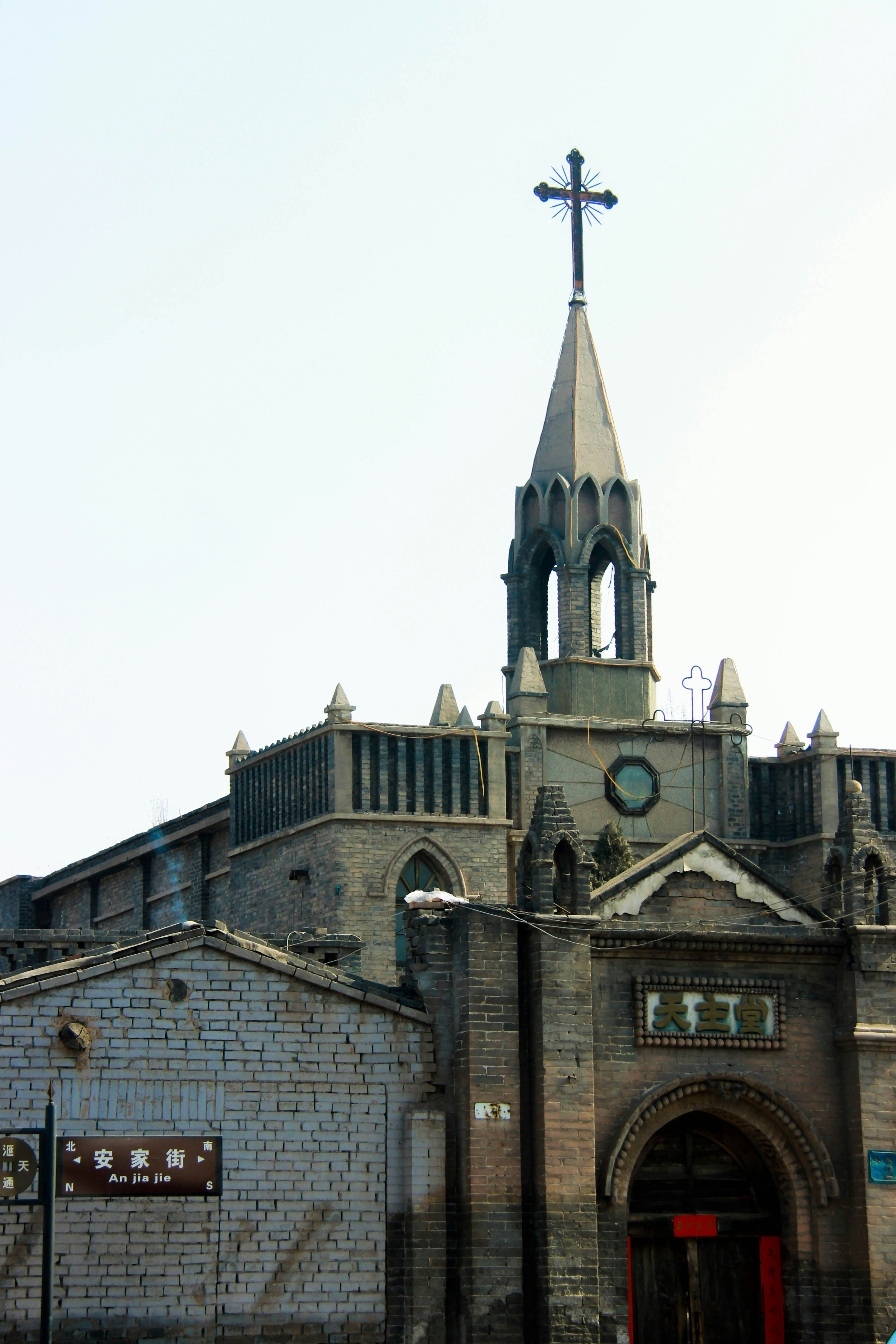 Stone Chapel Tower Rising Over Courtyard Walls