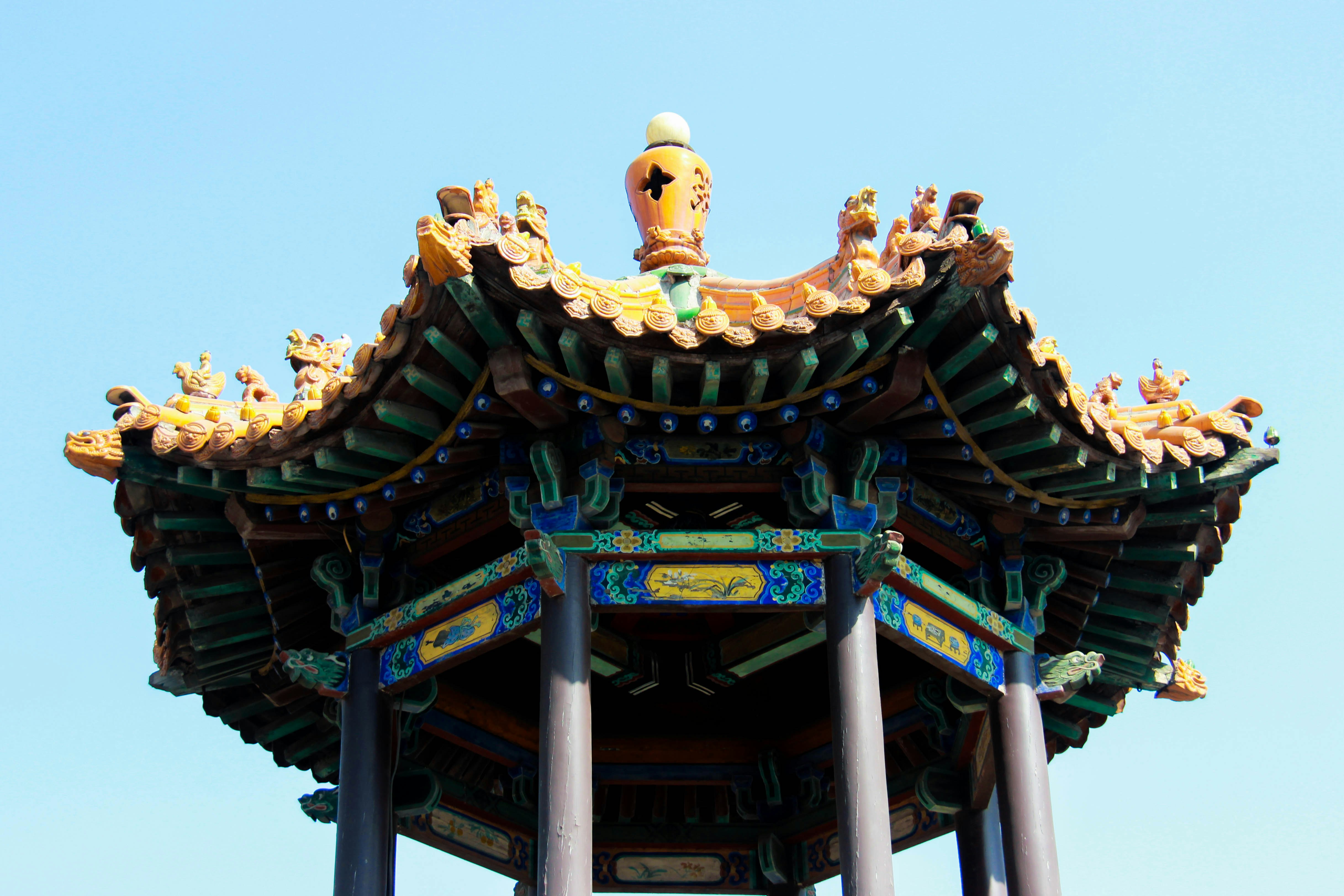 Ornate Pavilion Crowned by a Carved Finial Against a Clear Sky