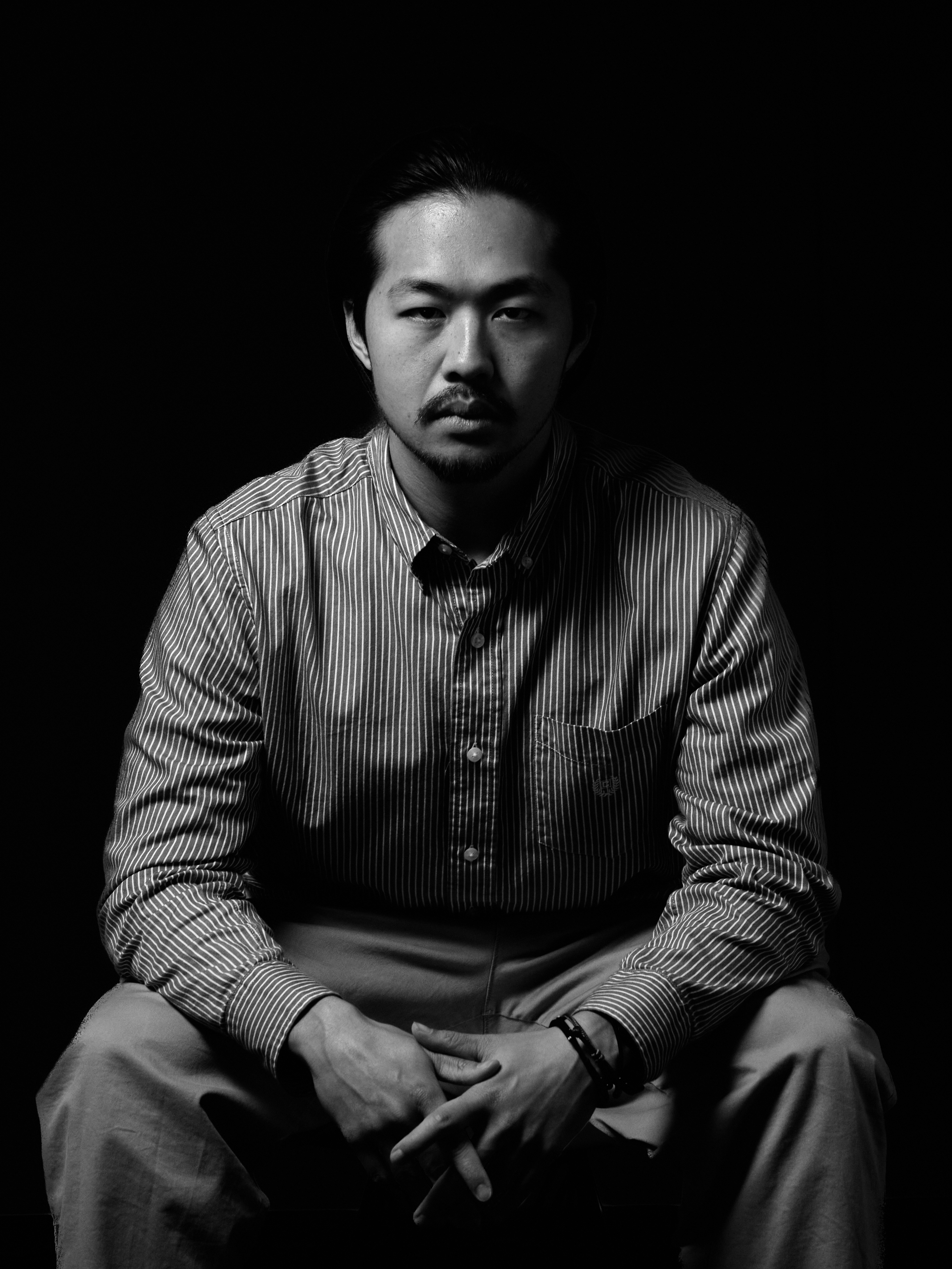 Quiet Authority: A Striped Shirt Portrait in Shadow