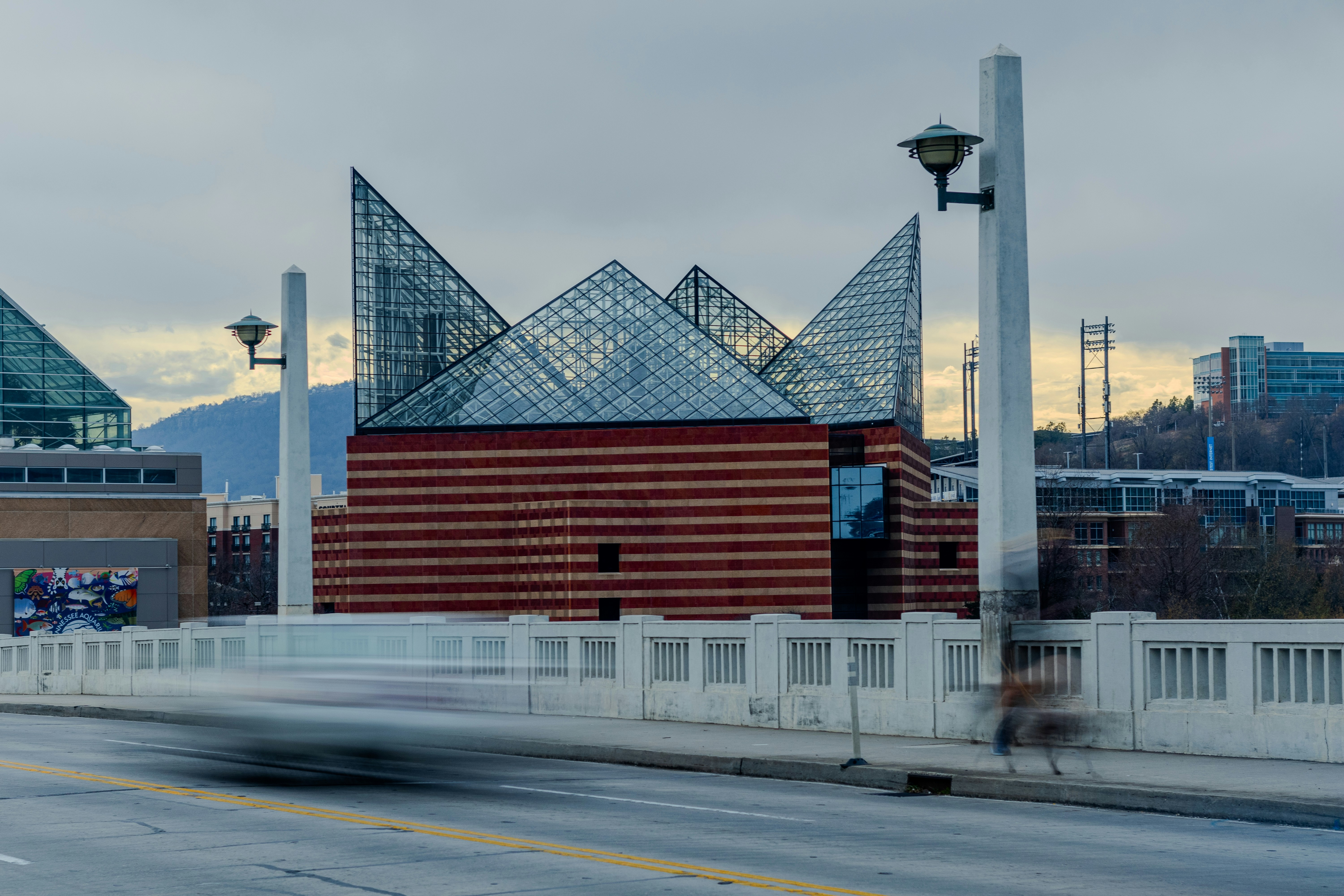 Urban Glass Facets on a Bridge: Geometric Rooflines and Moving Traffic