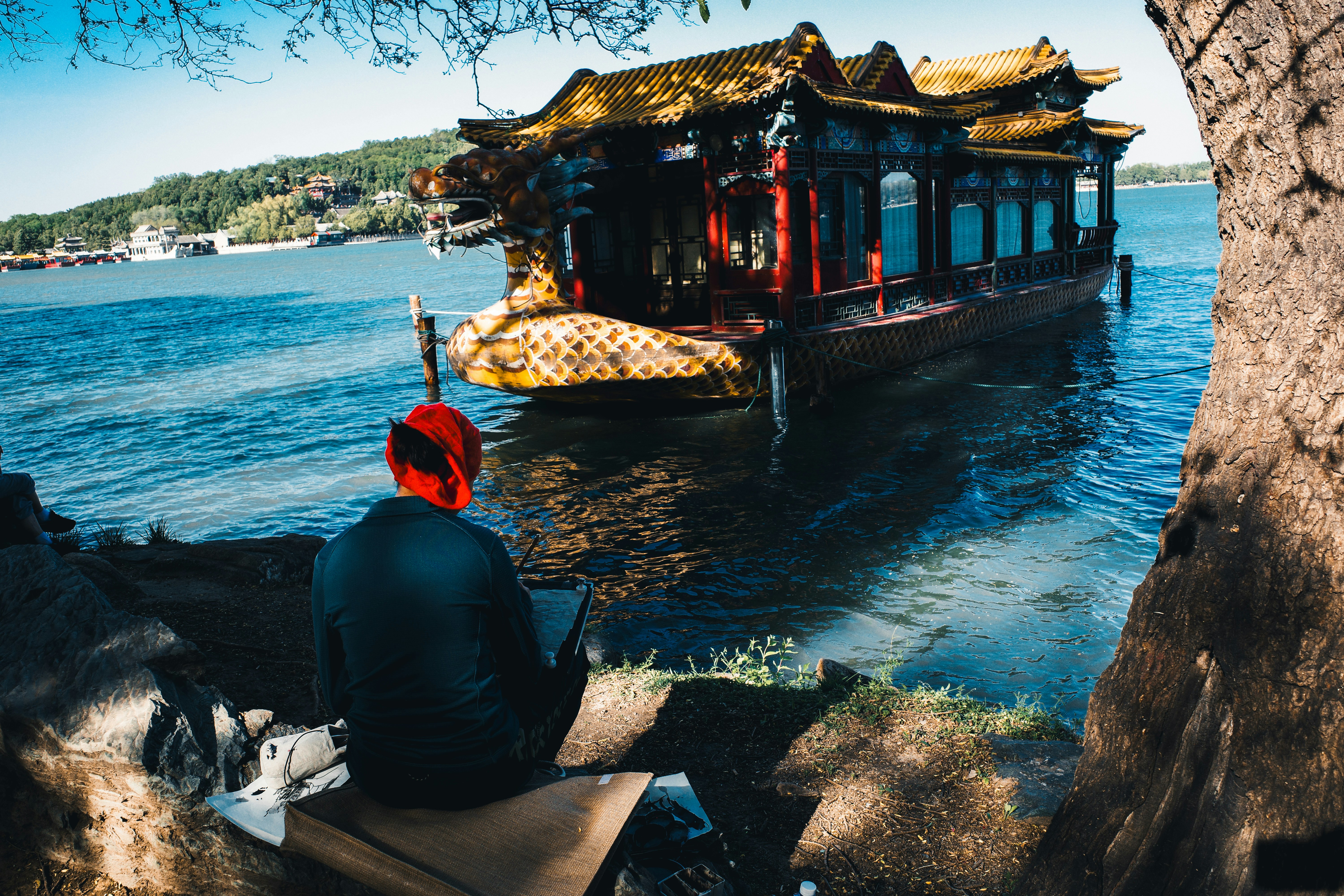 Quiet Moment by the Dragon Boat: Observer at the Shore