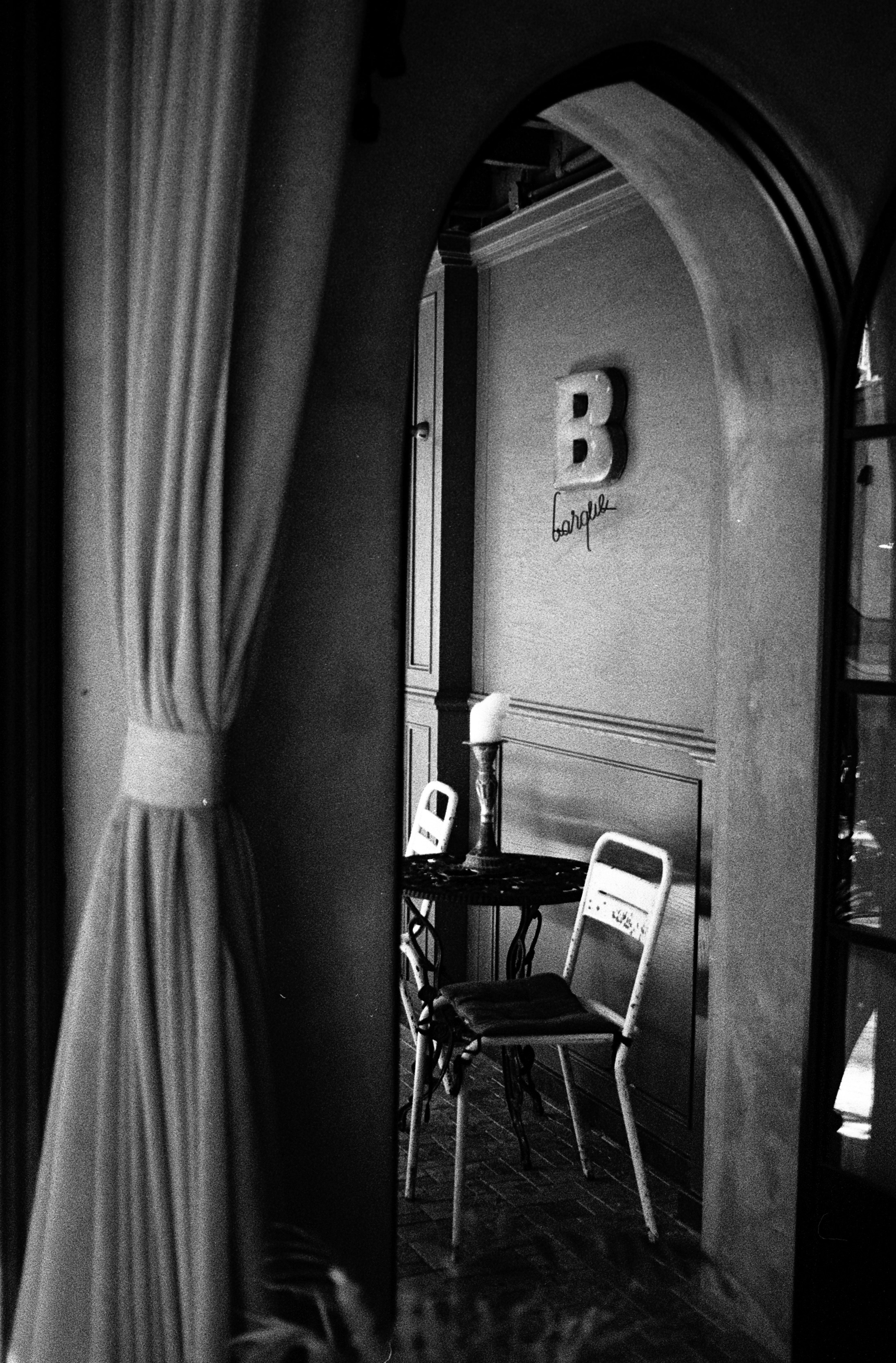Arched doorway with curtains and cafe seating
