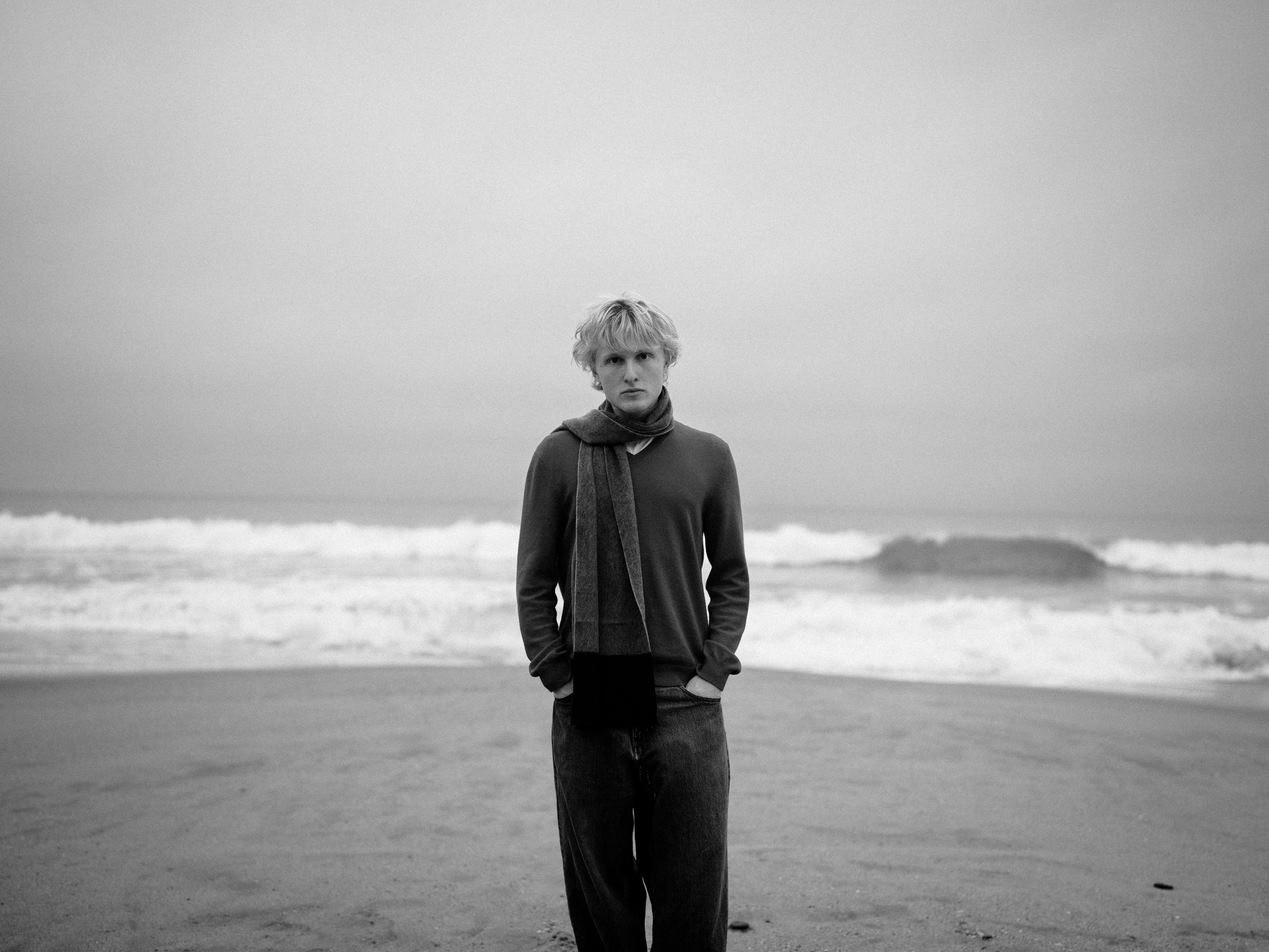 Coastal Quiet: A Lone Figure on Wind-Swept Sand