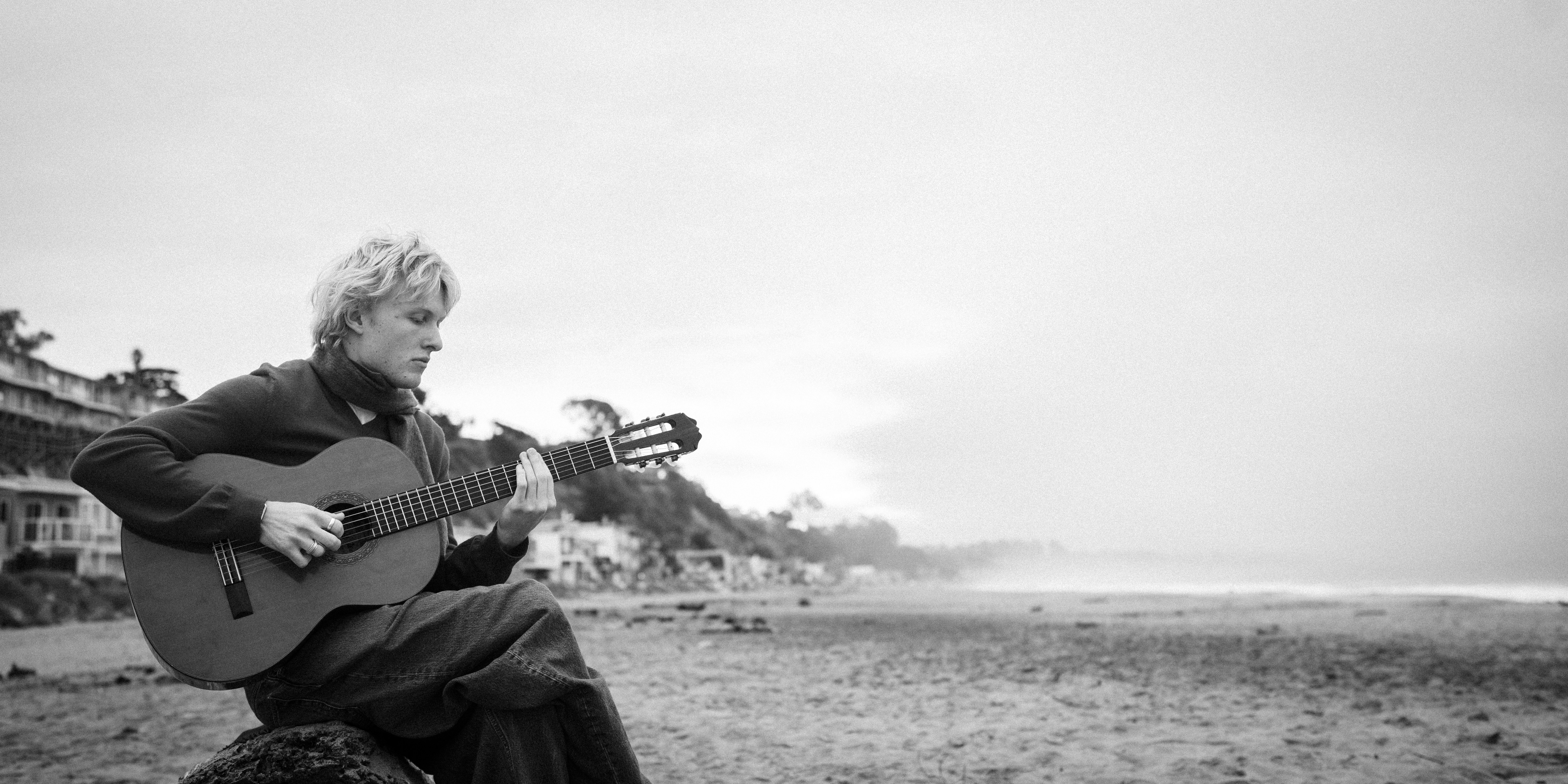 Guitar on the Shore: A Quiet Portrait in grayscale